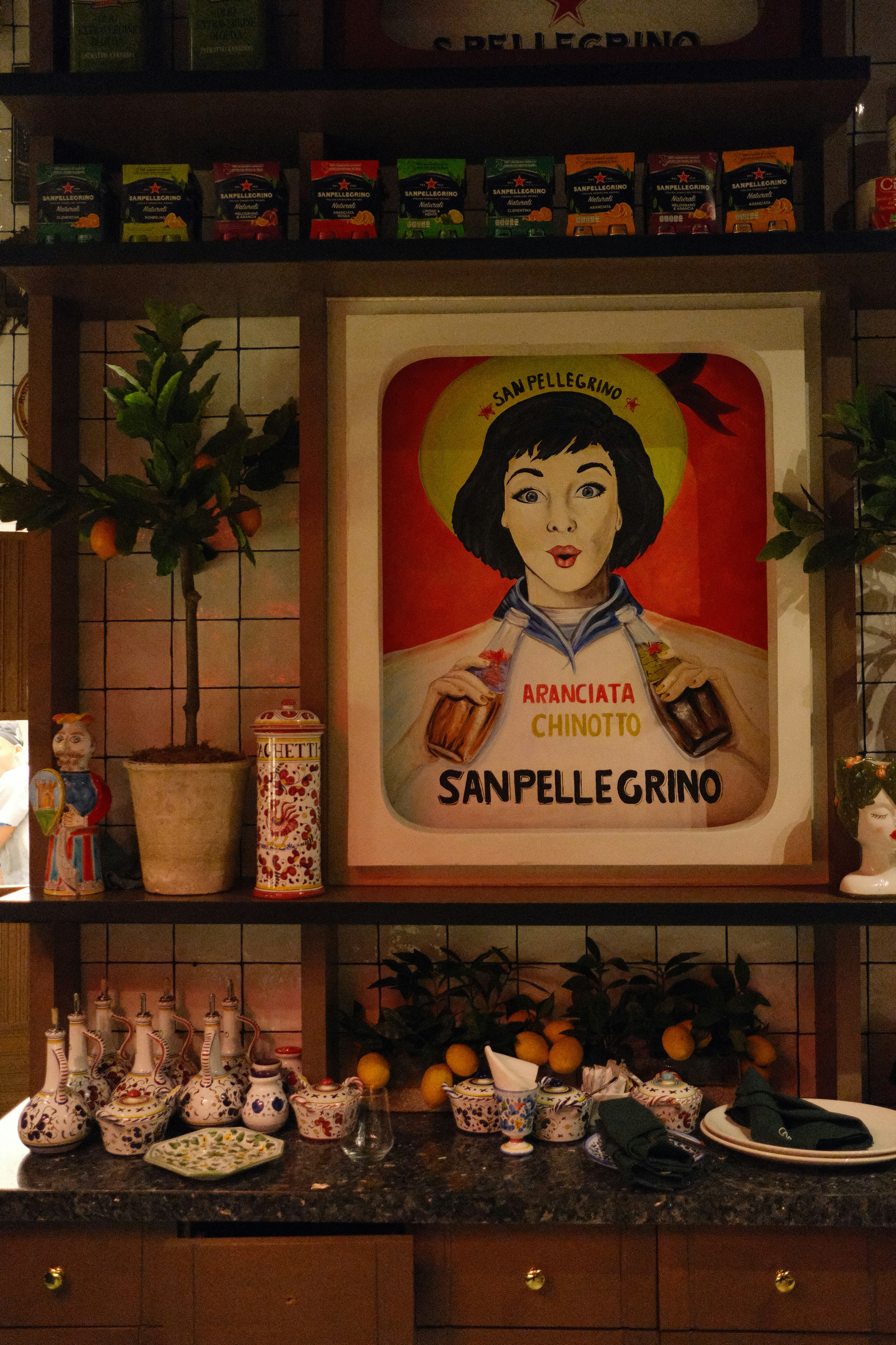Vintage Still Life: Framed Ad Art Surrounded by Citrus and Ceramics