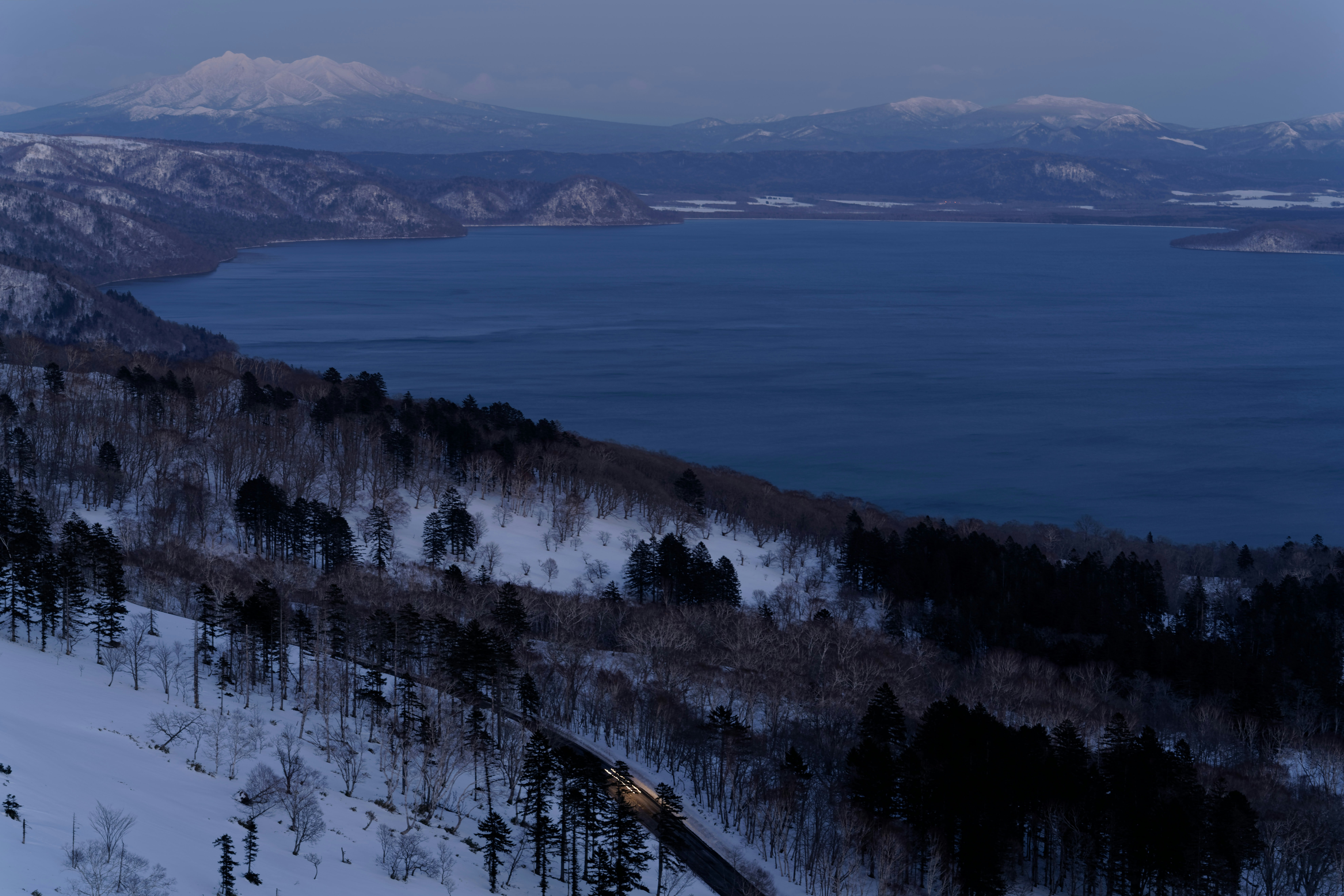 Blue Twilight Over Snow-Kissed Pines and Quiet Fjord