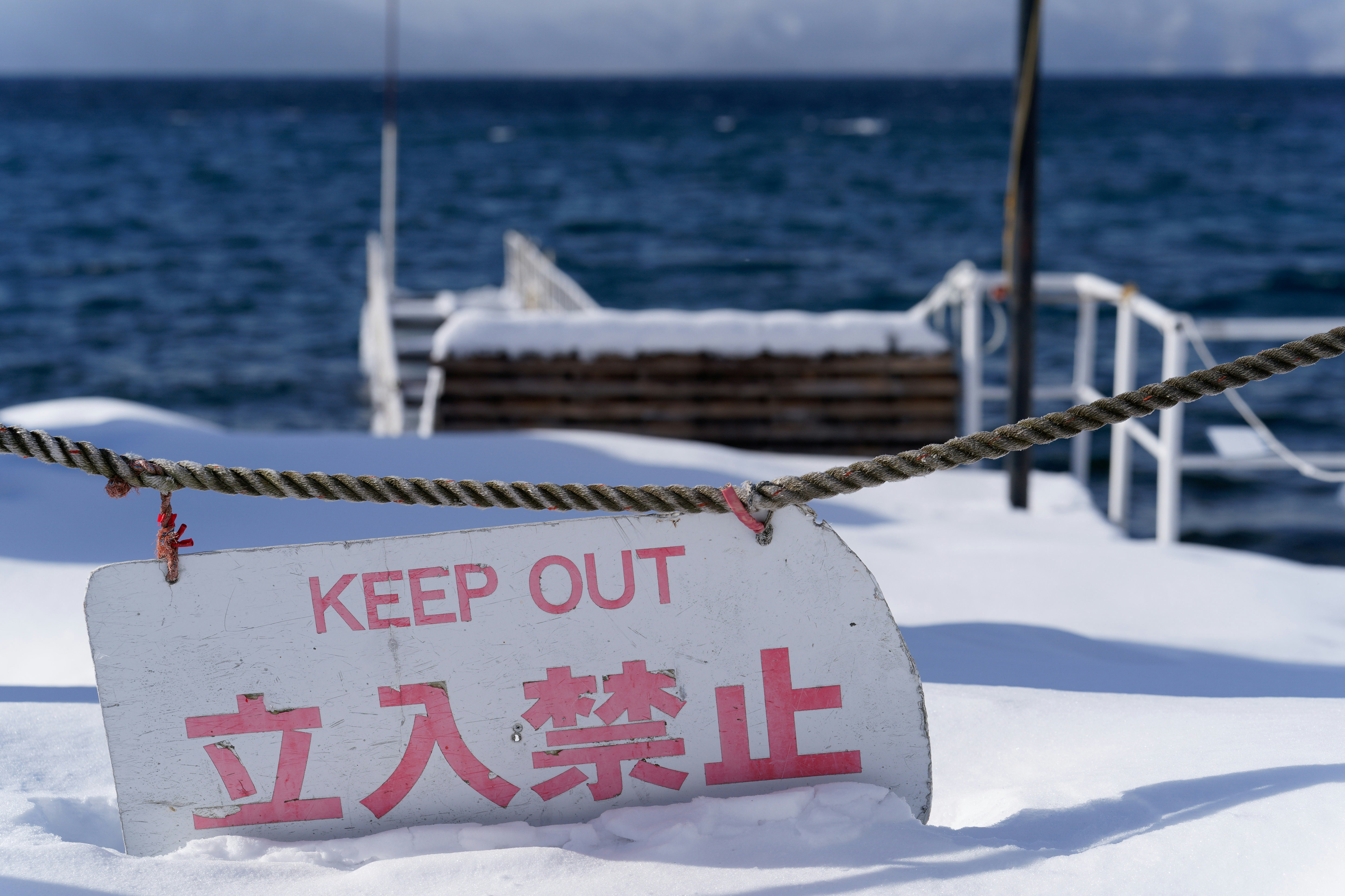 Snowbound Warning Sign by the Sea
