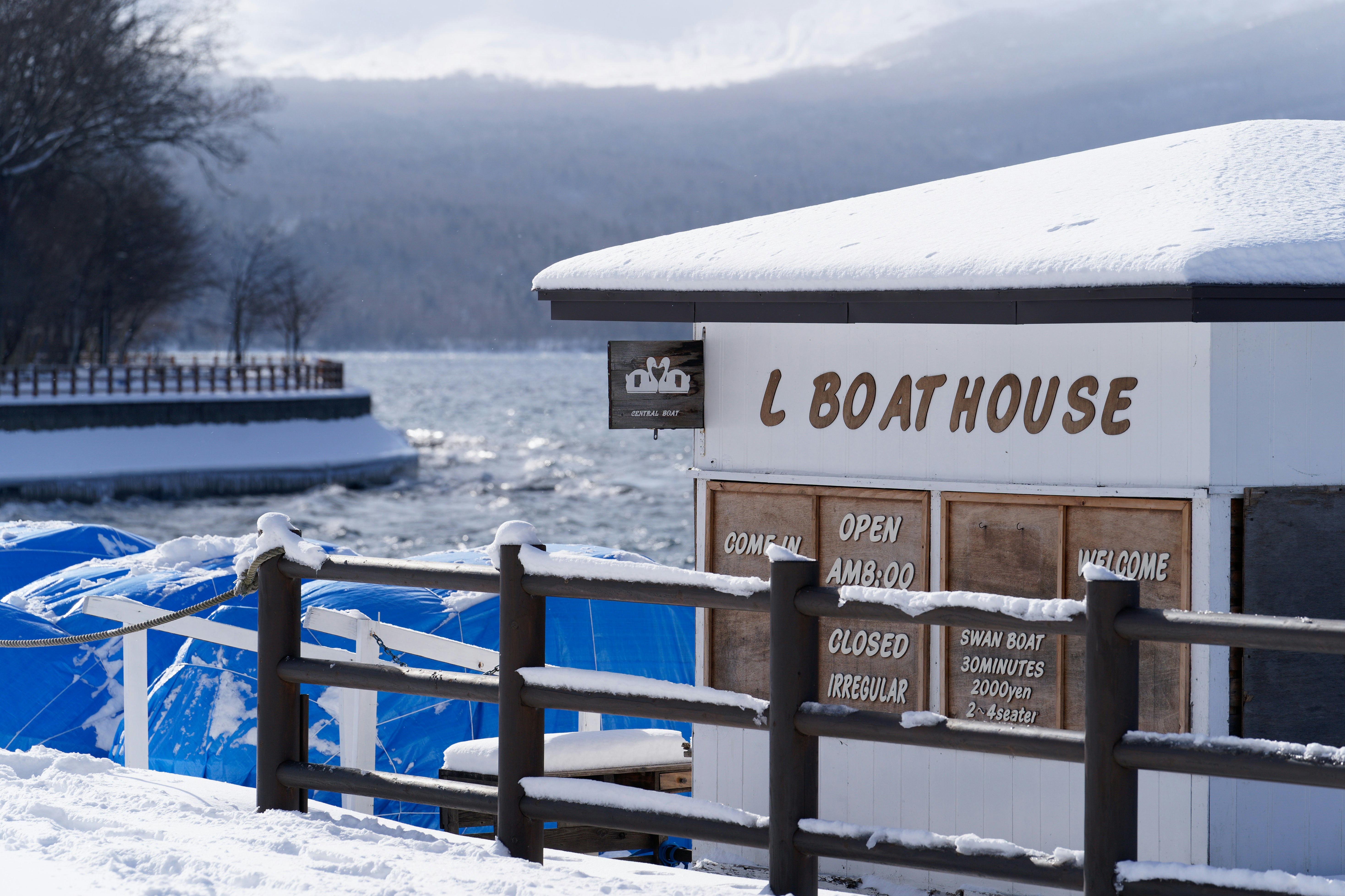 Snow-kissed Boathouse by the Icy Pier