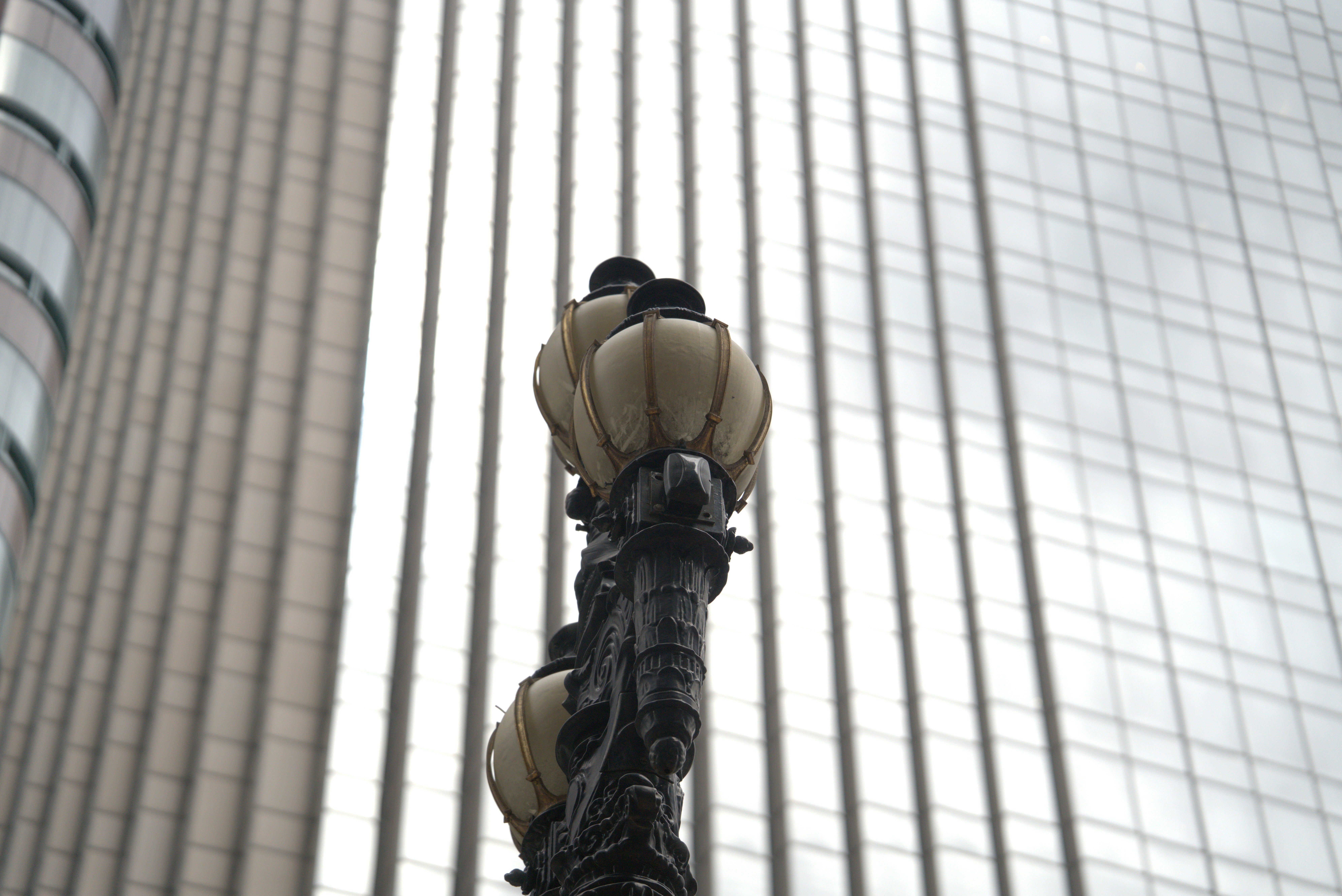 Ornate Lamp Post Piercing a Sky of Glass and Steel