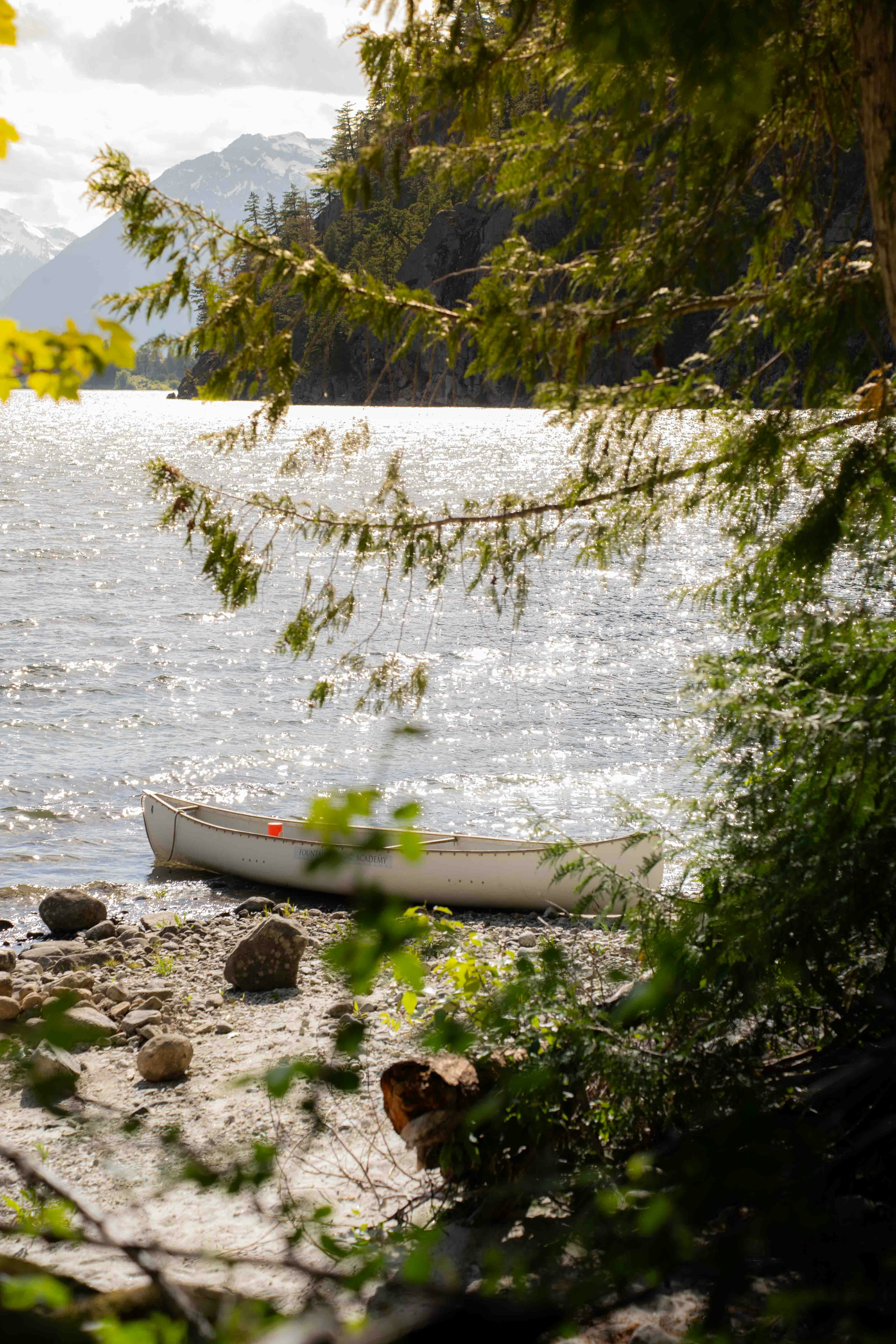 Boat Rest at the Edge of a Sunlit Alpine Shore
