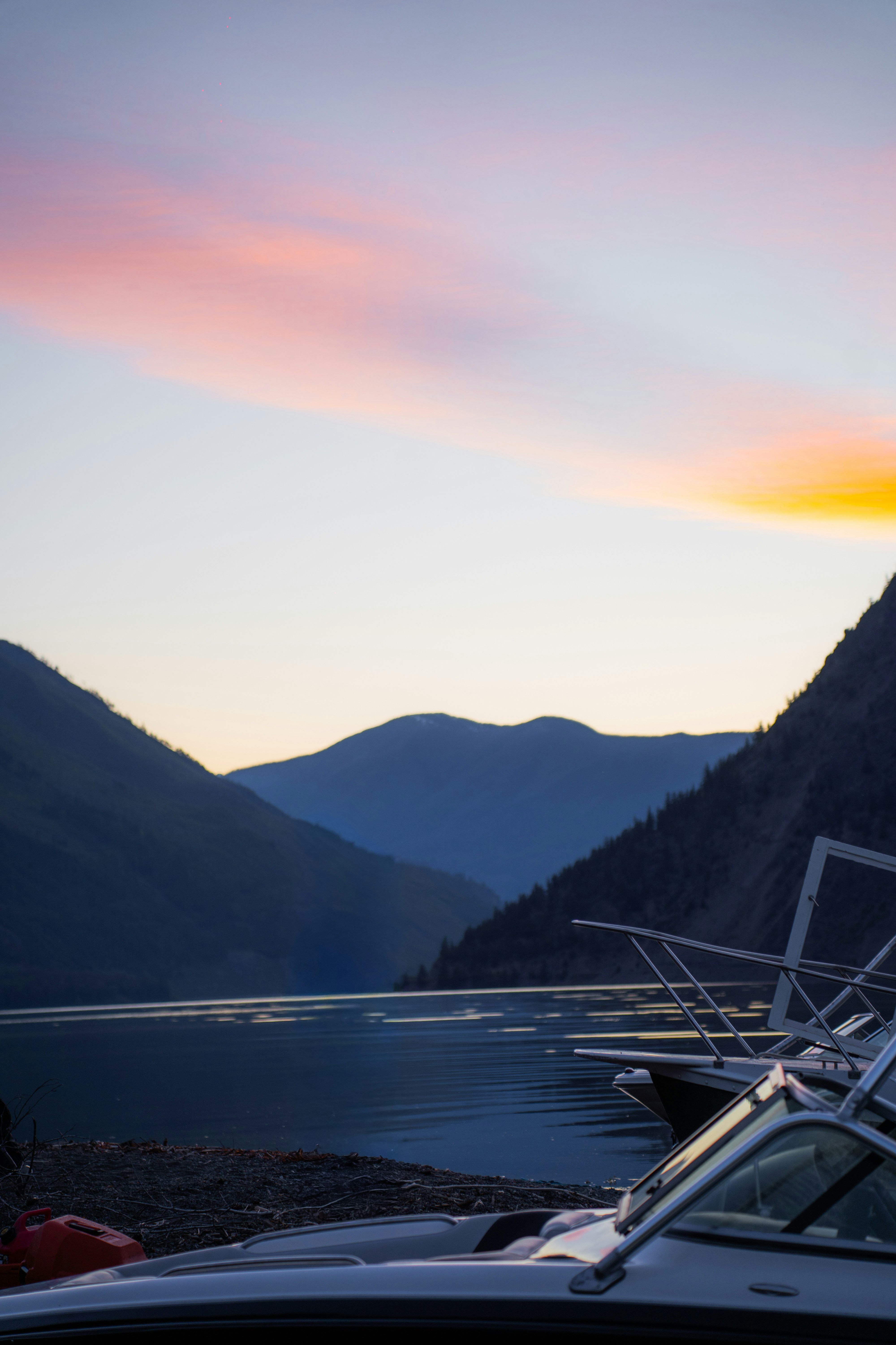 Sunset Over Serene Alpine Lake with Docked Boat