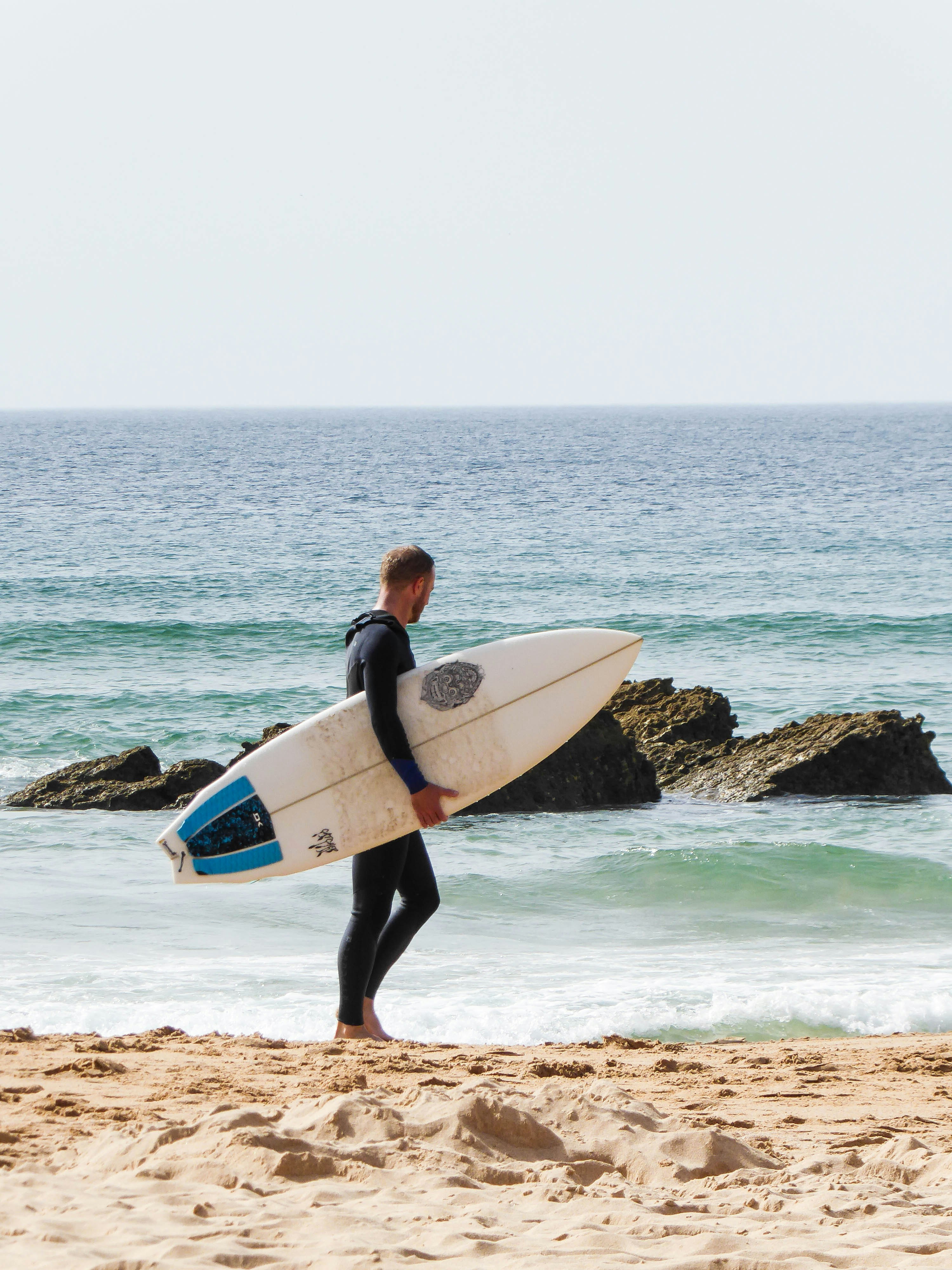 Surfer with a Whiteboard: A Quiet Walk to the Sea