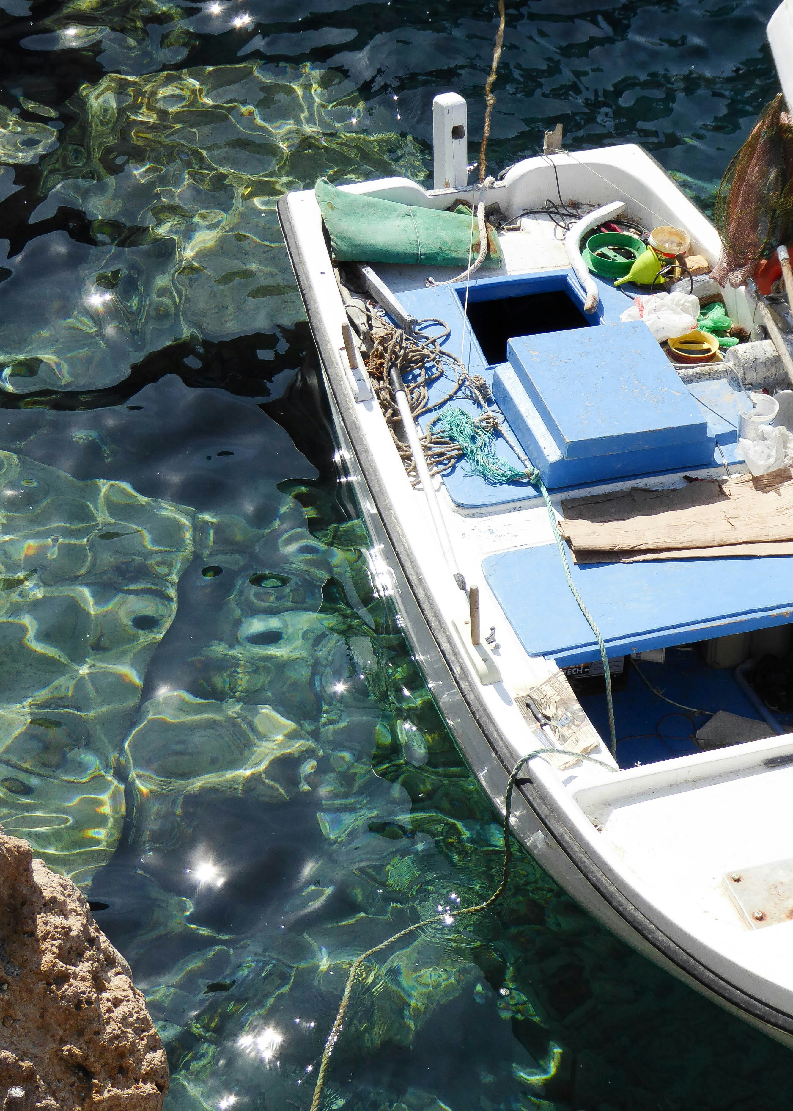 Lifebuoy Echo: A Seaside Boat Resting in Clear Coastal Waters