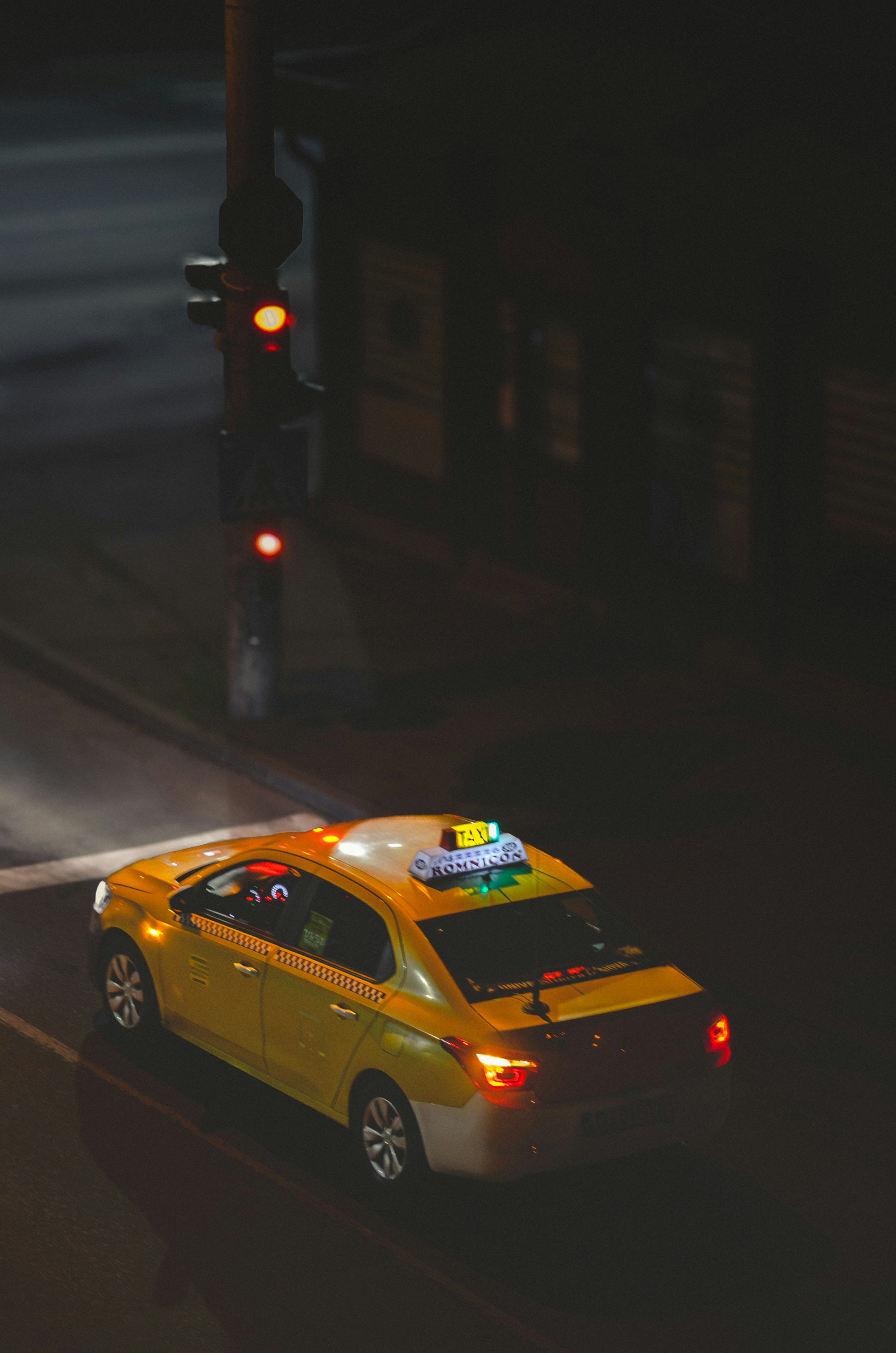 Midnight Yellow: A Taxi Glides Through Urban Red Lights