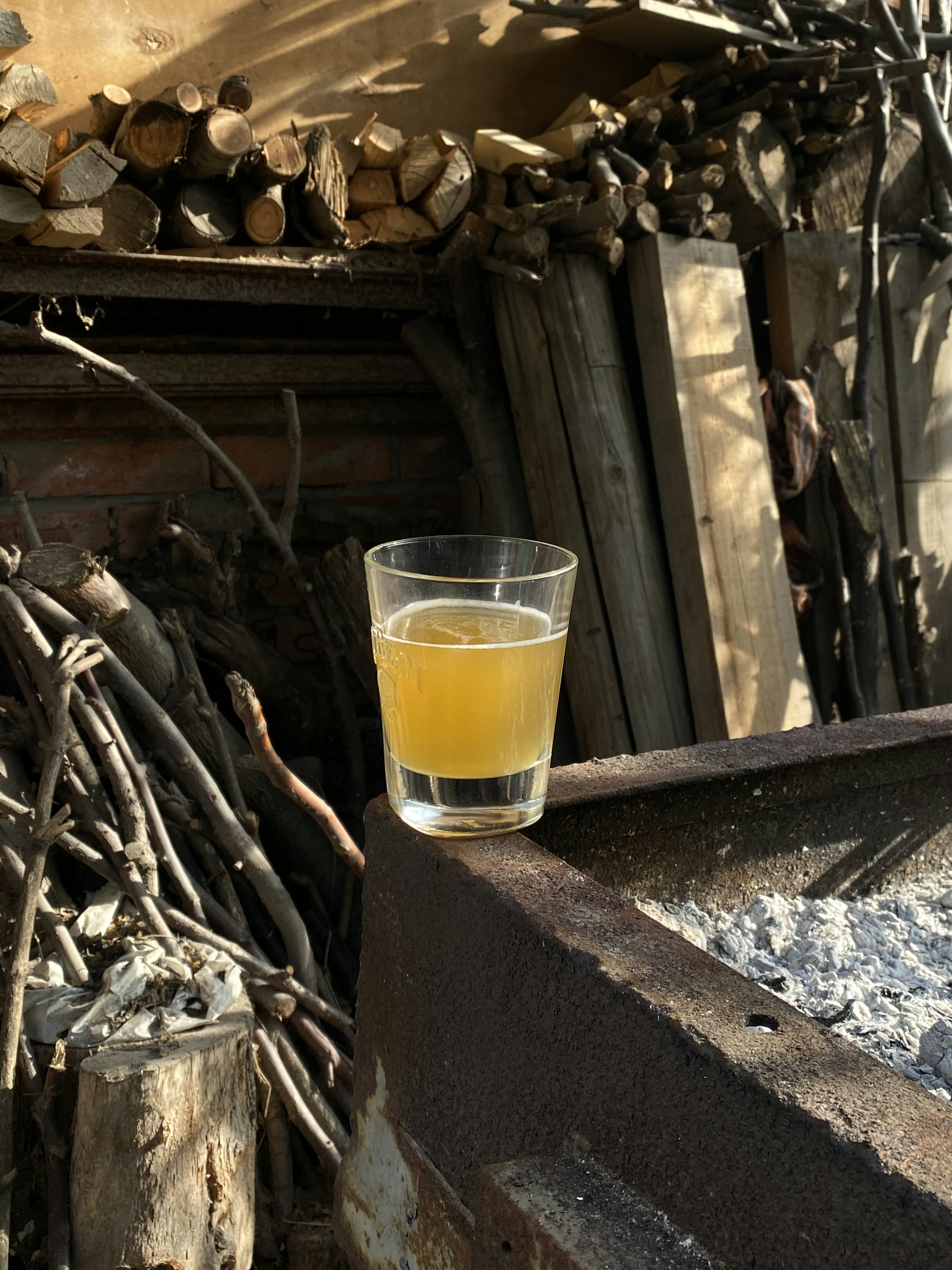 Sunlit Glass of Amber on a Rusty Stage