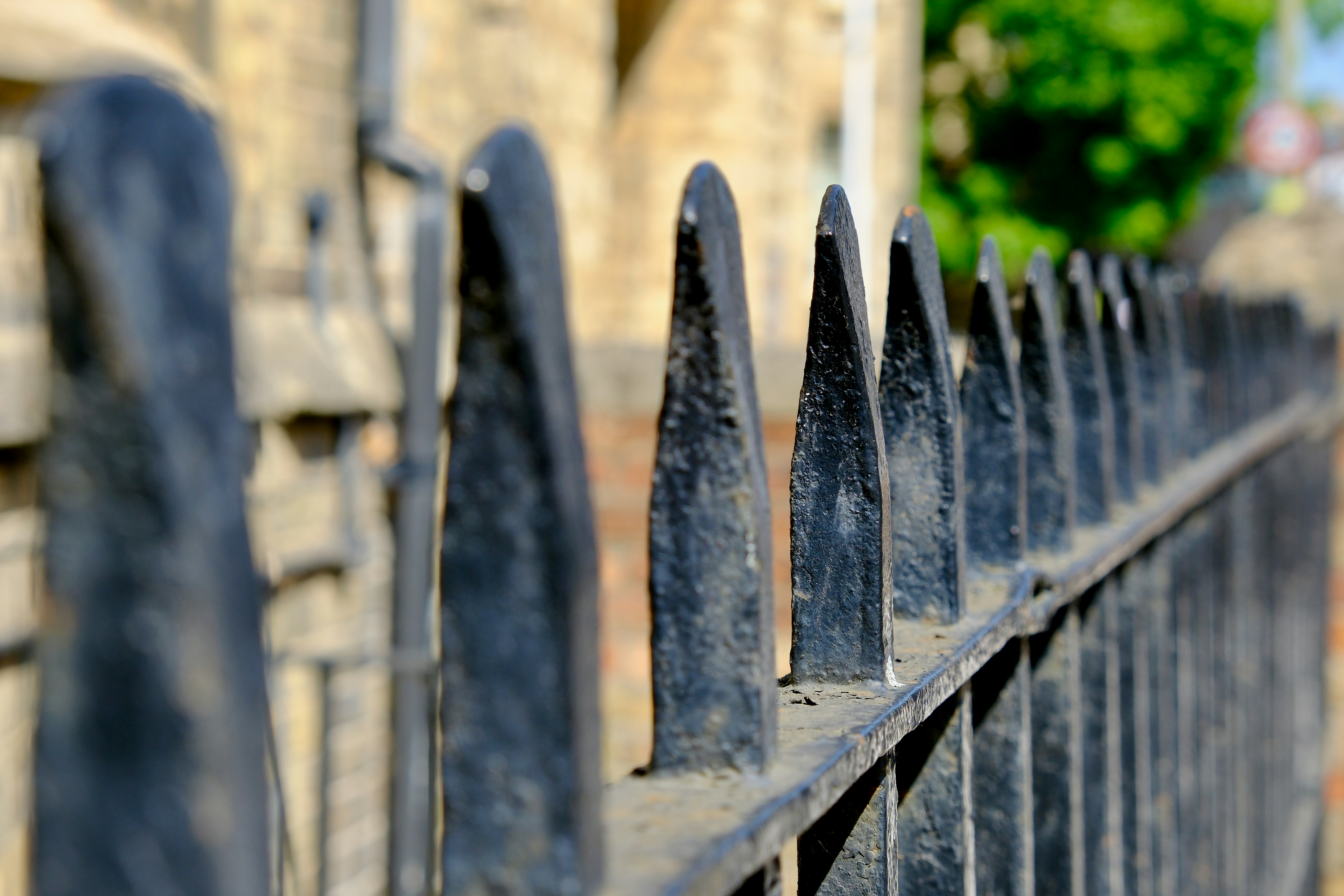 Industrial Fence Spikes: A Close-Up of Weathered Iron Lines