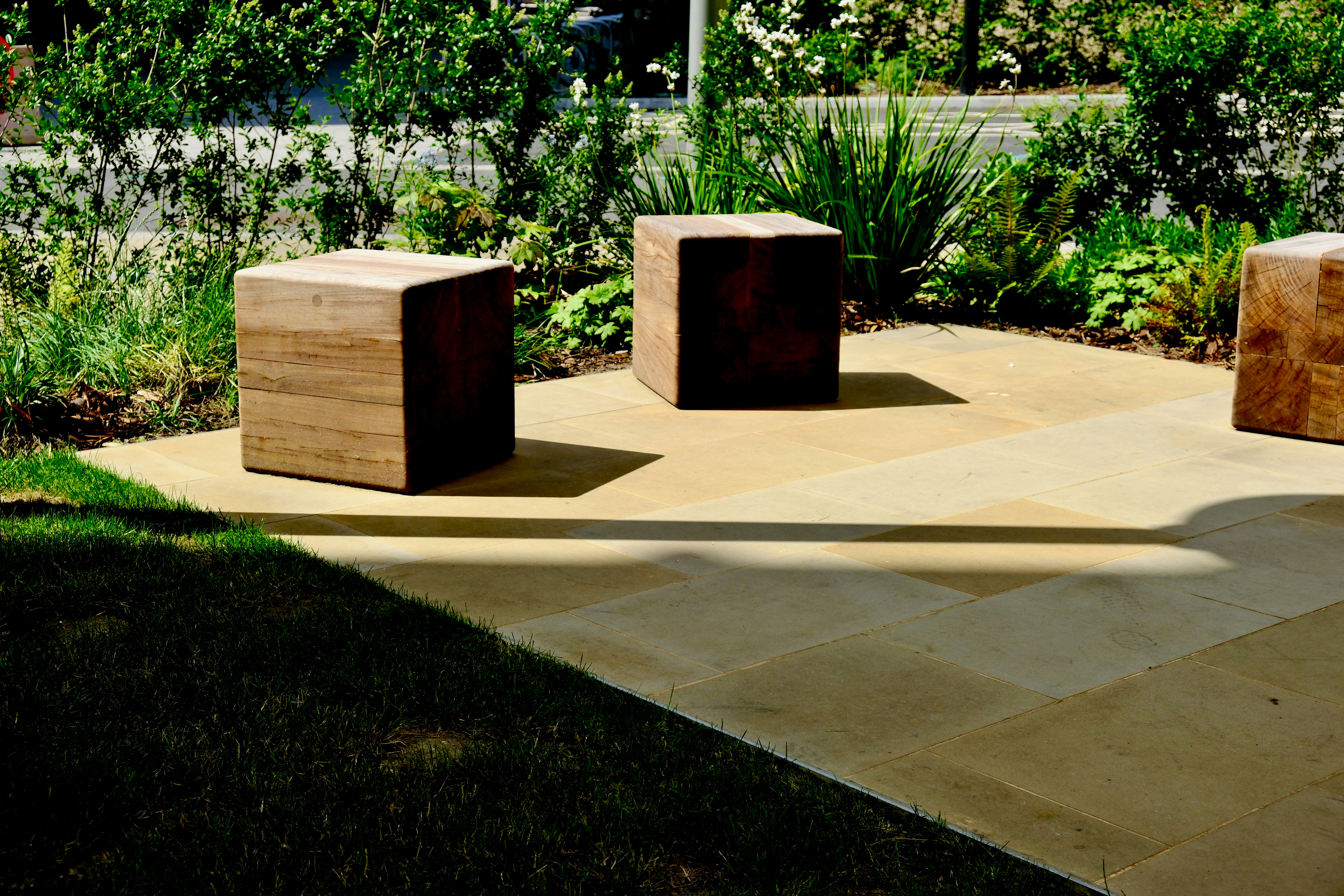 Sunlit Concrete Sanctuary with Floating Wooden Blocks