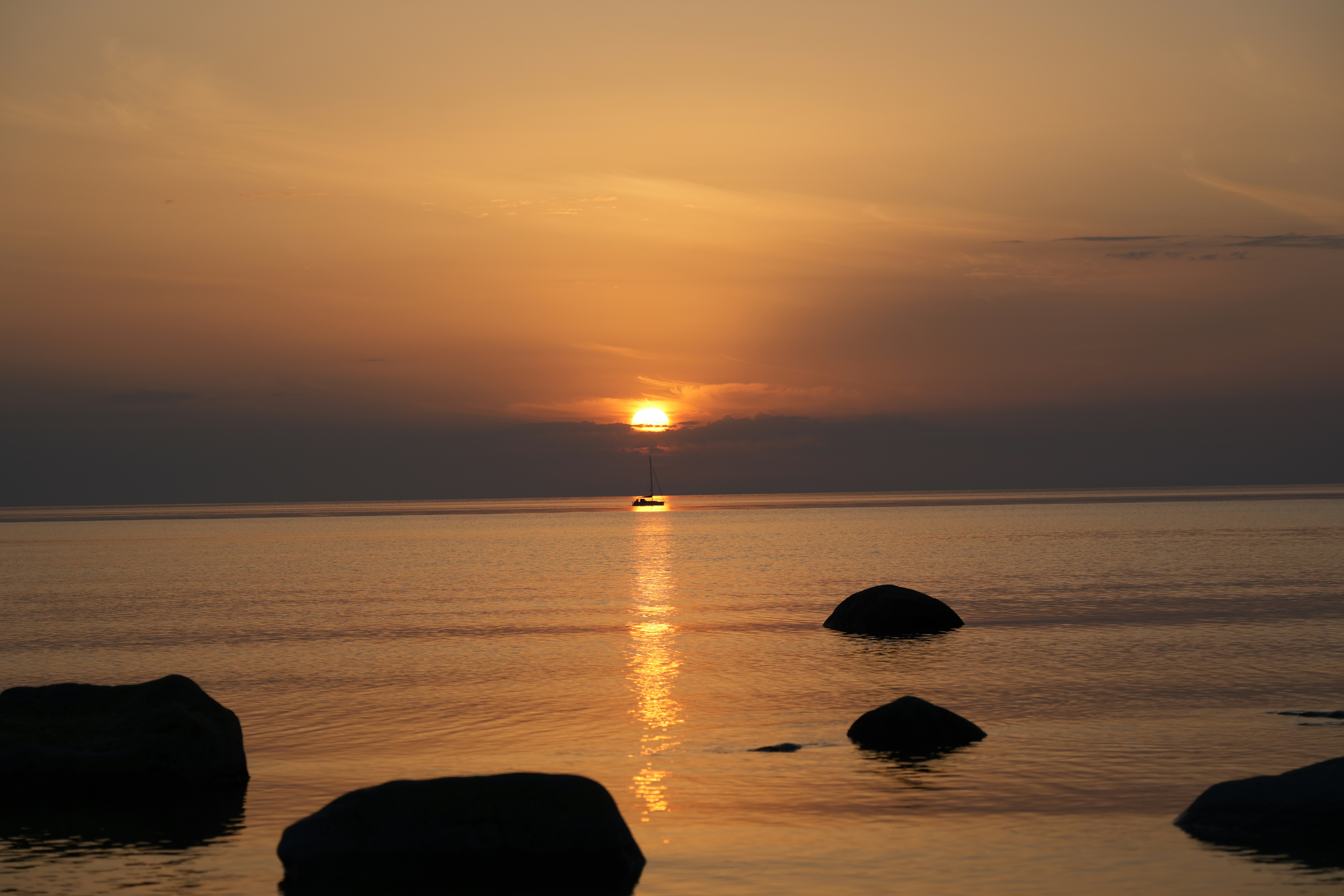 Sundown on Still Waters: The Sun Touching the Horizon
