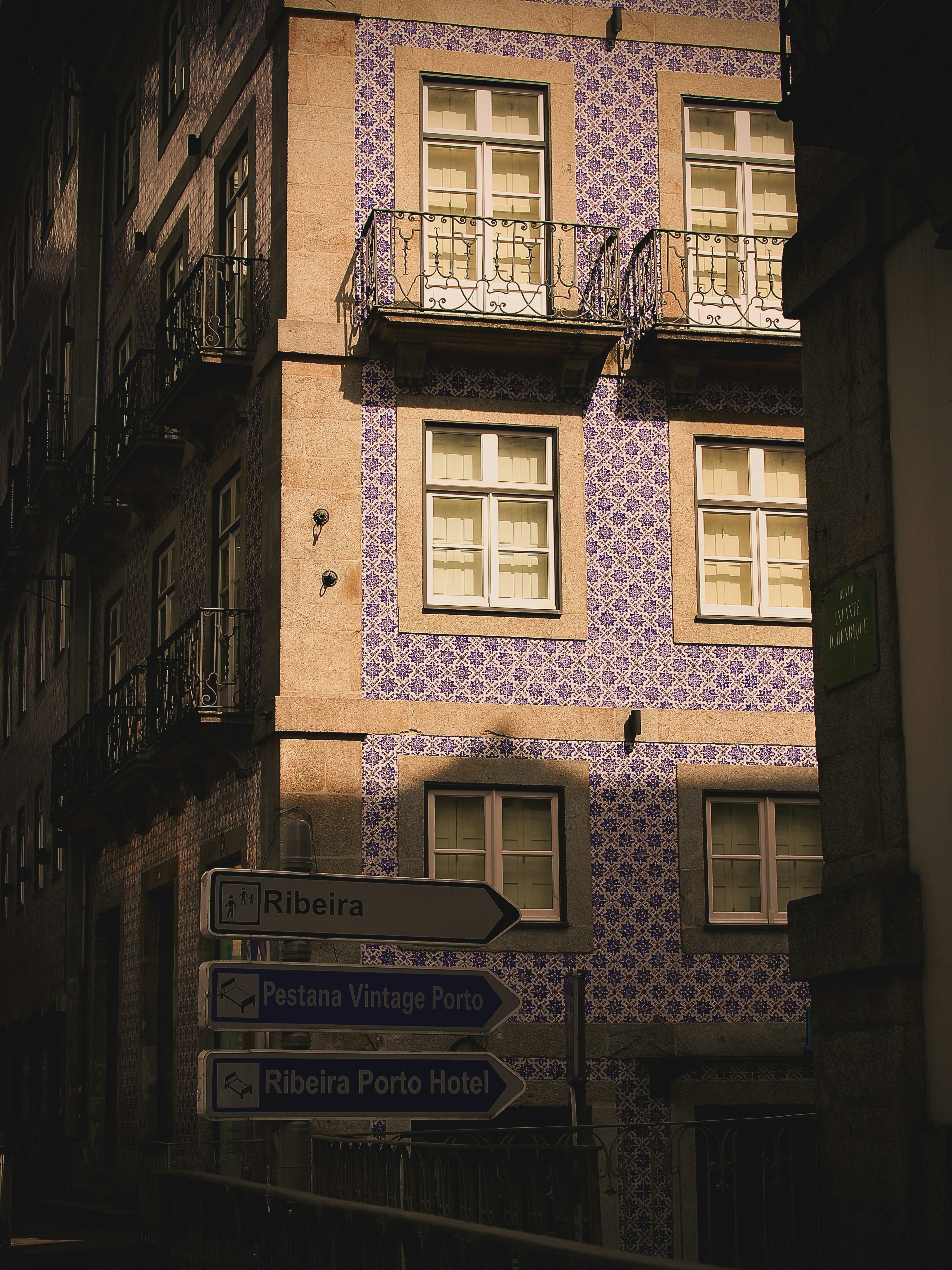 Blue Tile Facade Under Narrow Balcony Light