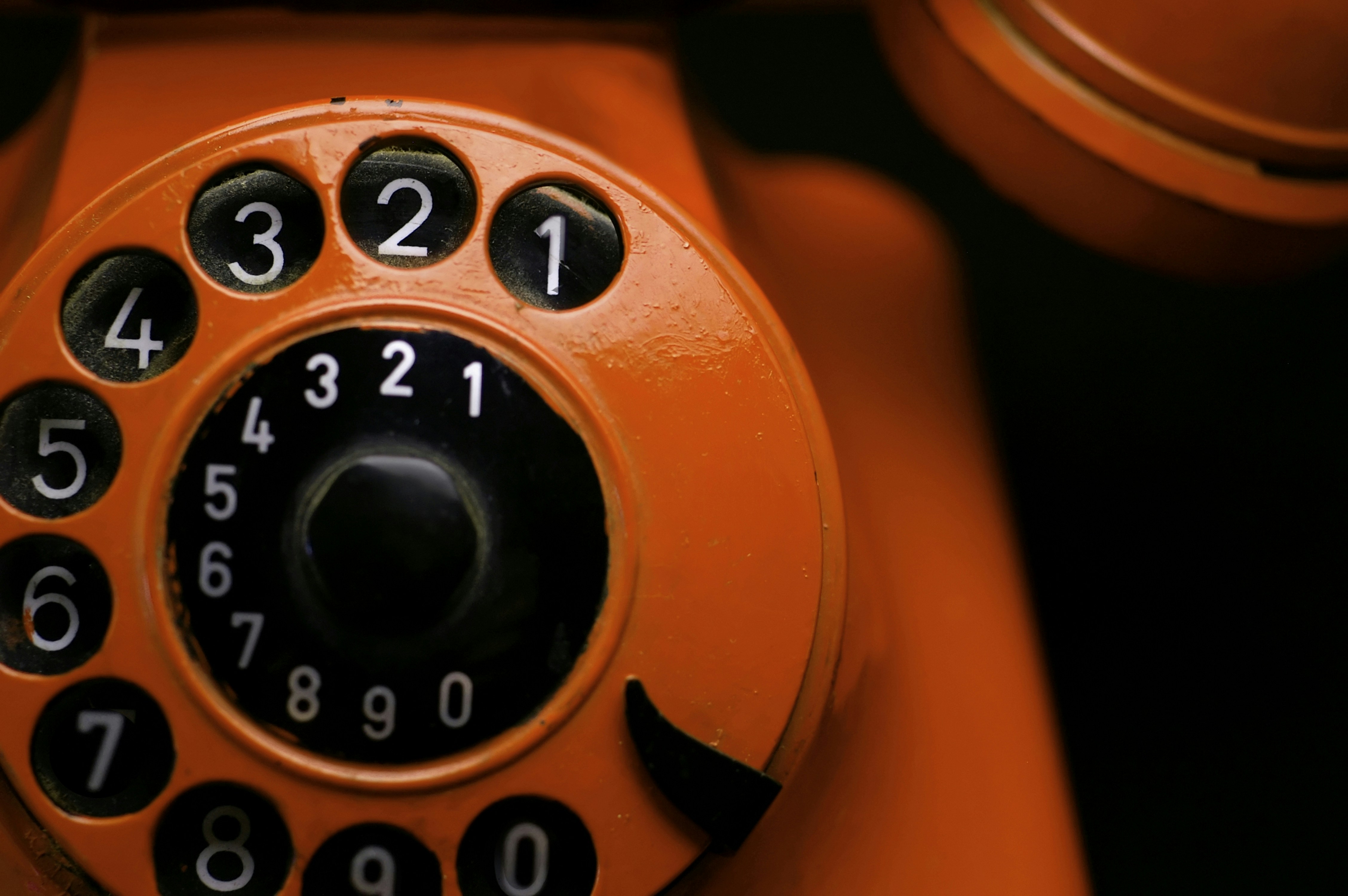 Rotary Orange: A Close-Up of the Vintage Payphone Dial