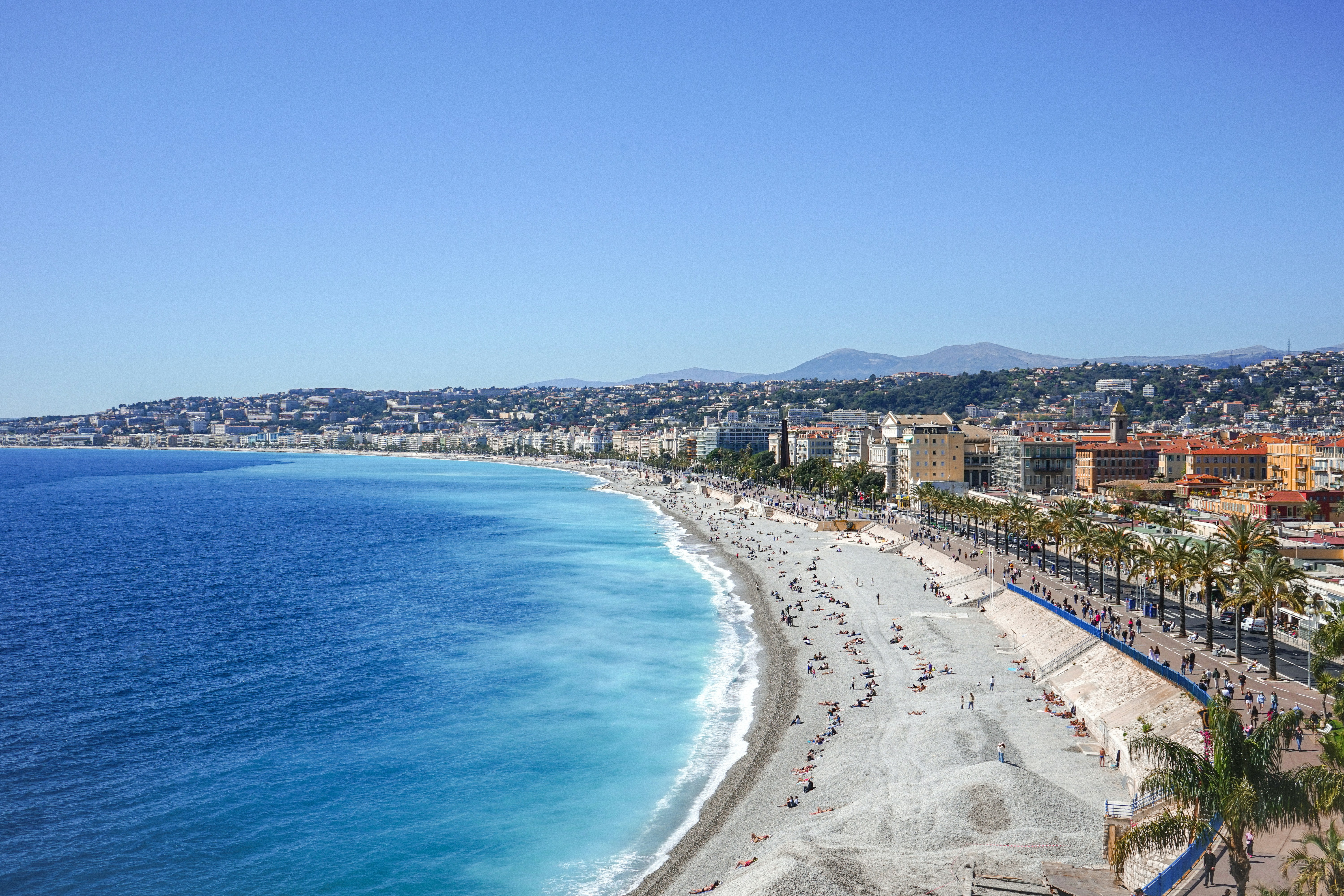 Sunlit Promenade Along a Mediterranean Beach