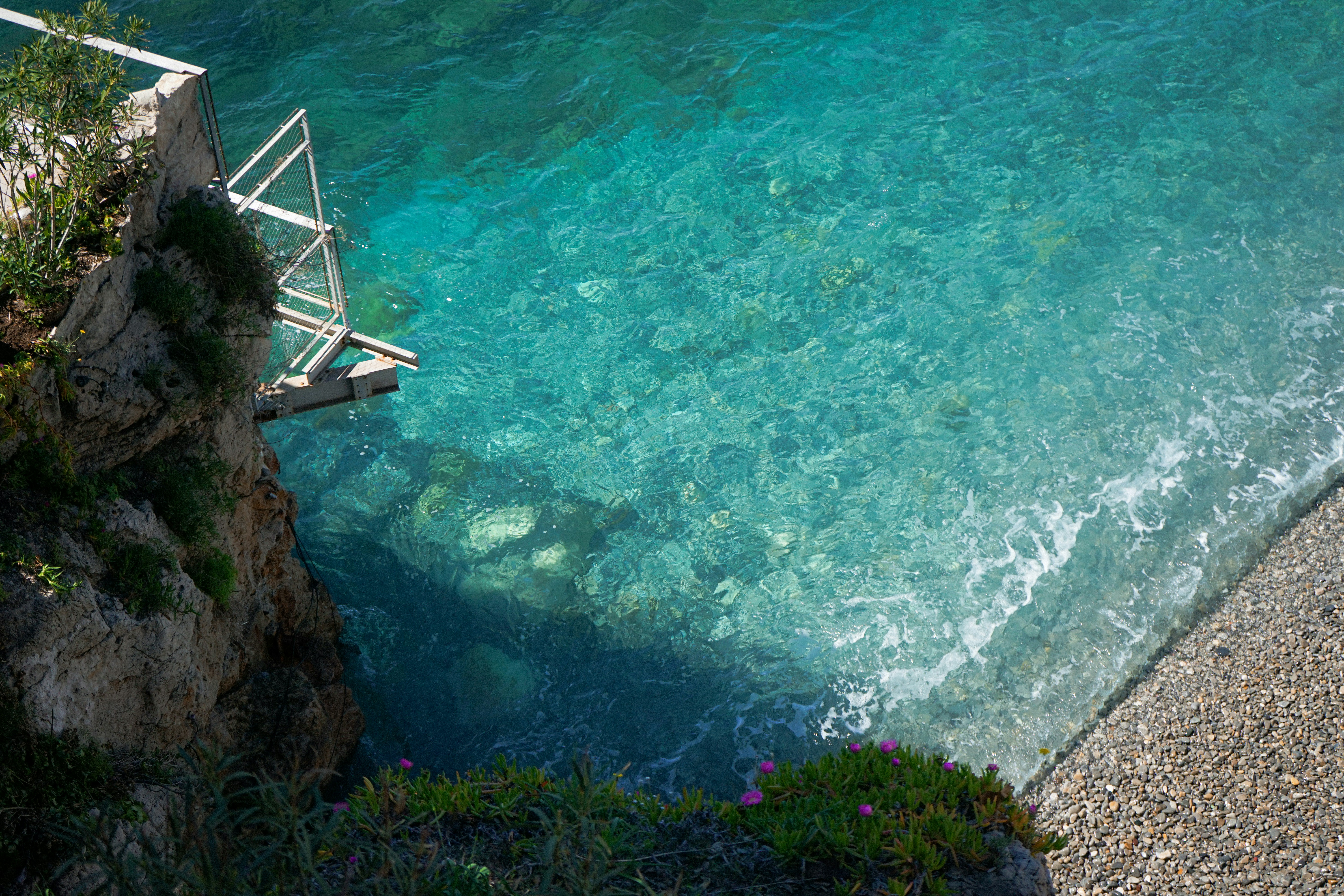 Cobalt Steps Adrift: A Cliffside Descent into Turquoise Waters