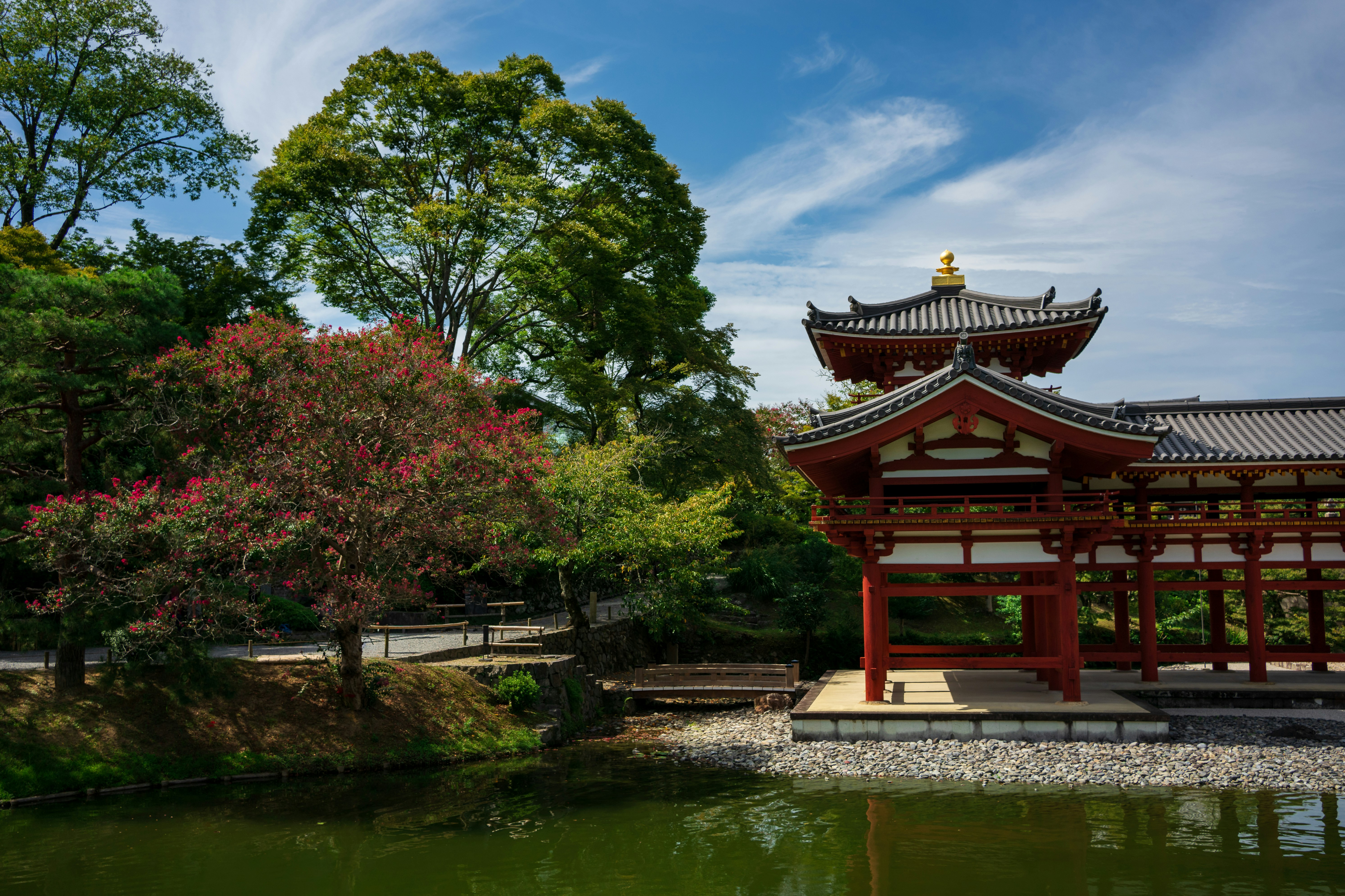 Red Gate Overlooking a Tranquil Pond at a Japanese Temple Garden