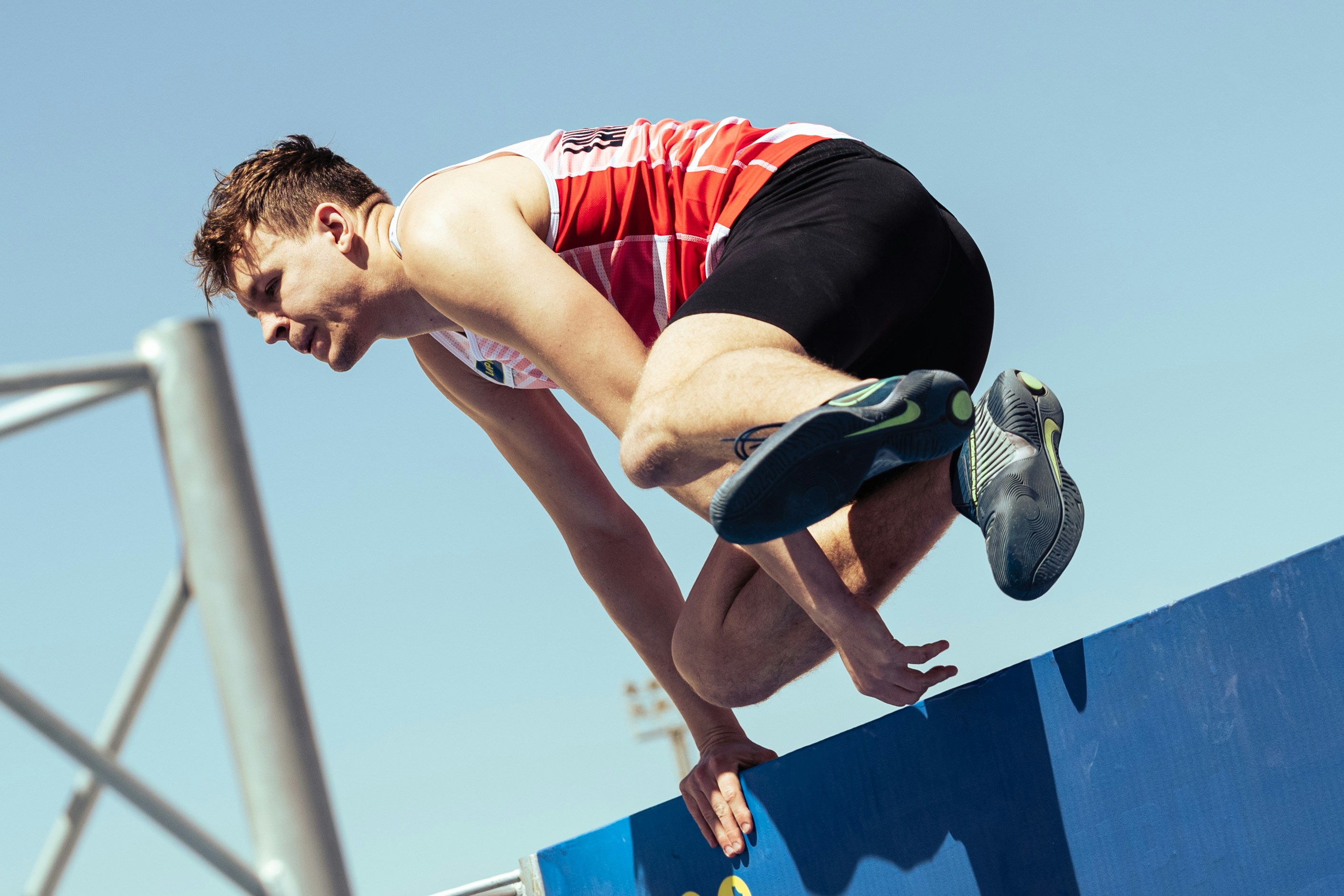 Leap Over the Barrier: A Sprinter in Mid-Flight