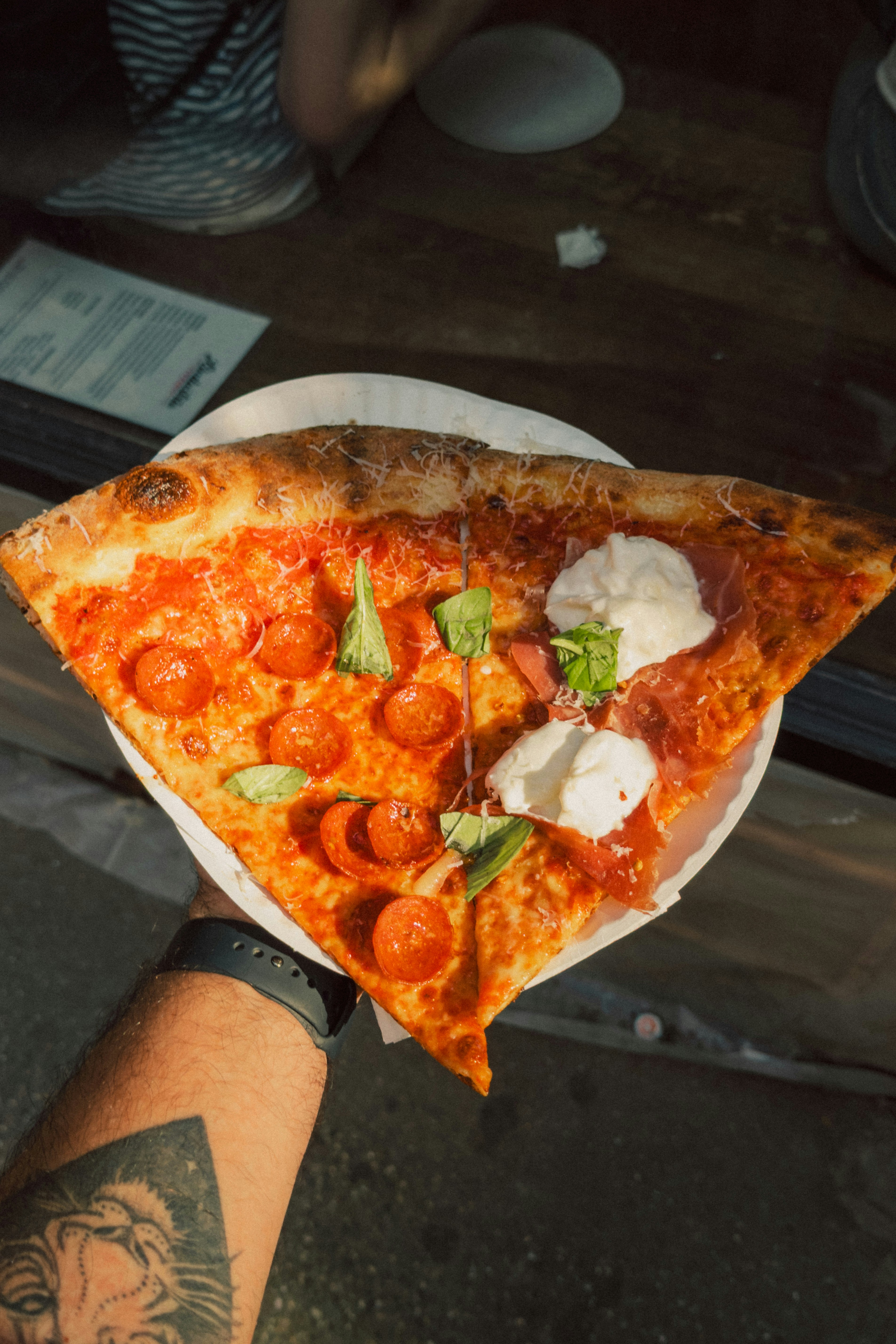A Triangular Slice of Pepperoni and Basil, Held Over a Dark Street