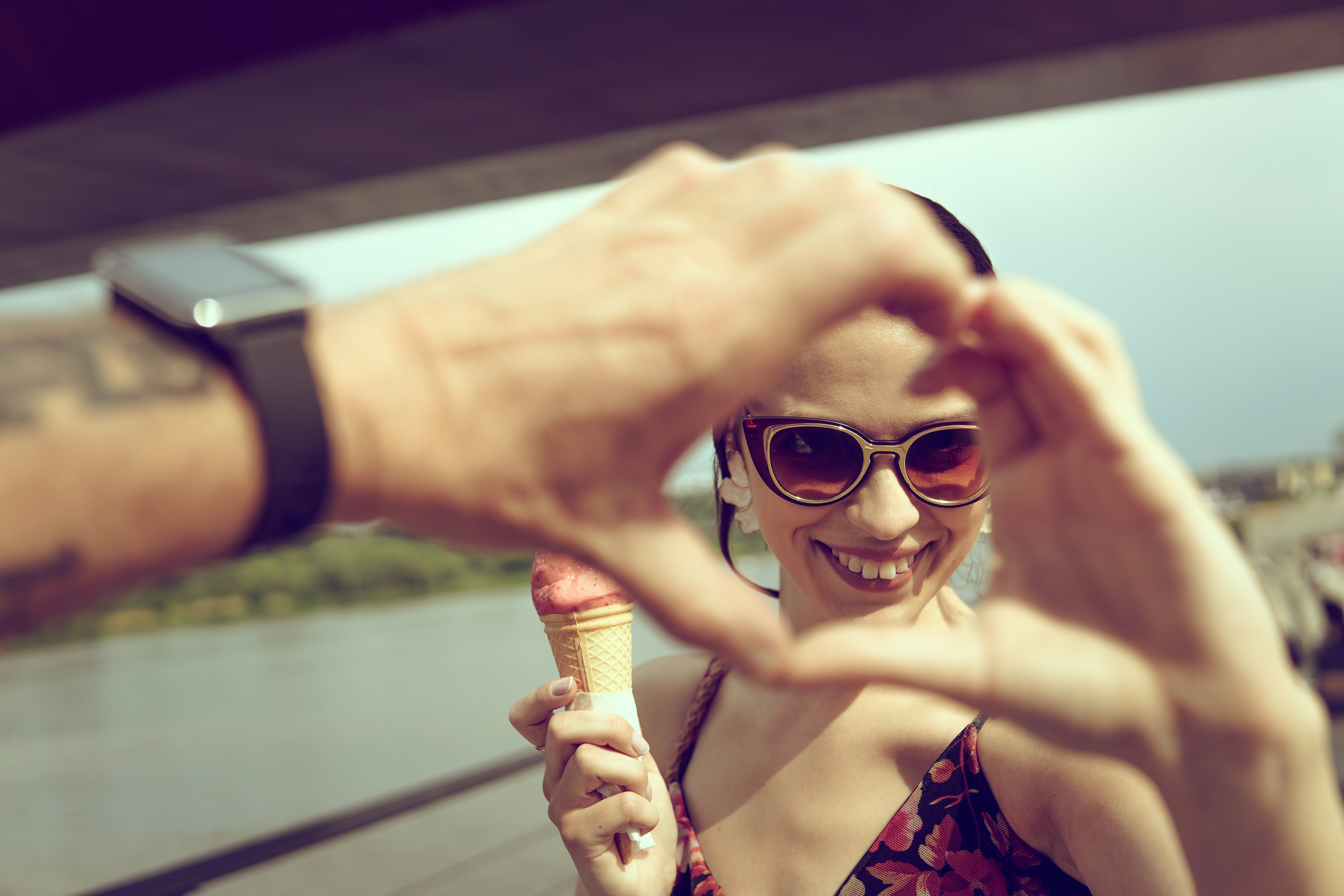 Framing a Smile: Hands Form a Heart Around the Ice Cream