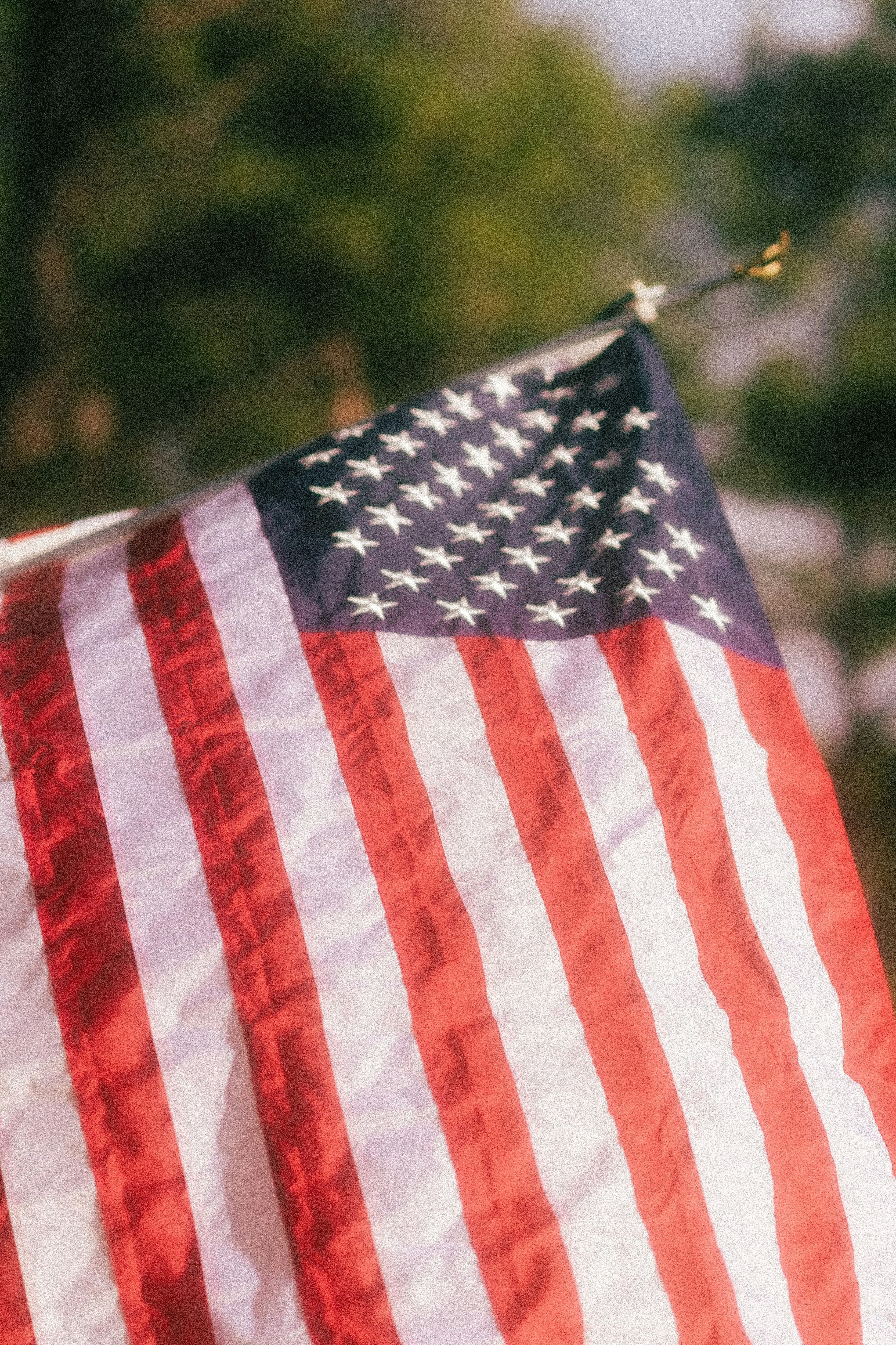 Flag in Tilted Light: A Close-Up of Stripes and Stars