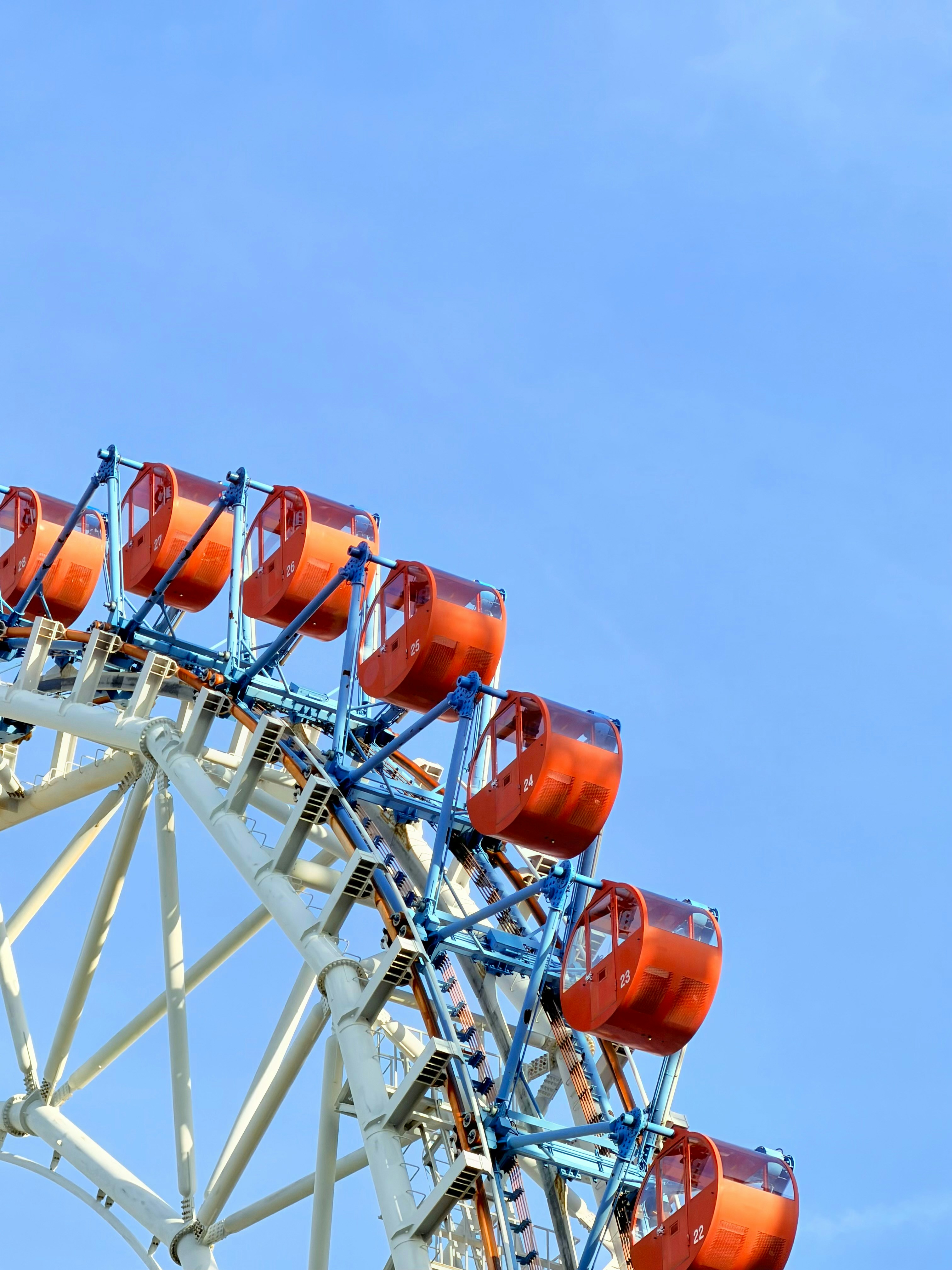 Skyward Wheels: A Ferris Arc Rising Against a Clear Blue