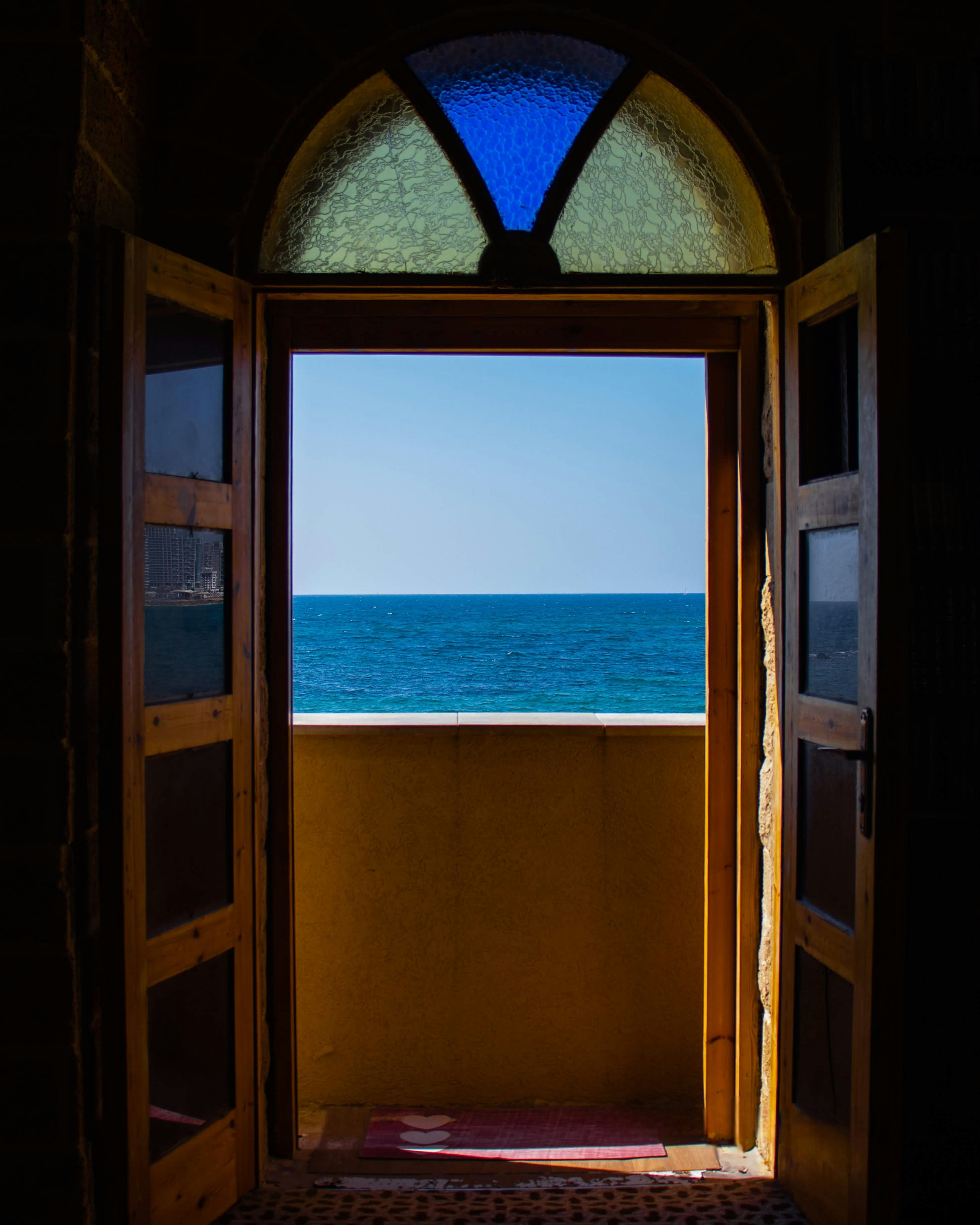 Ocean View Framed by a Dim Interior Doorway