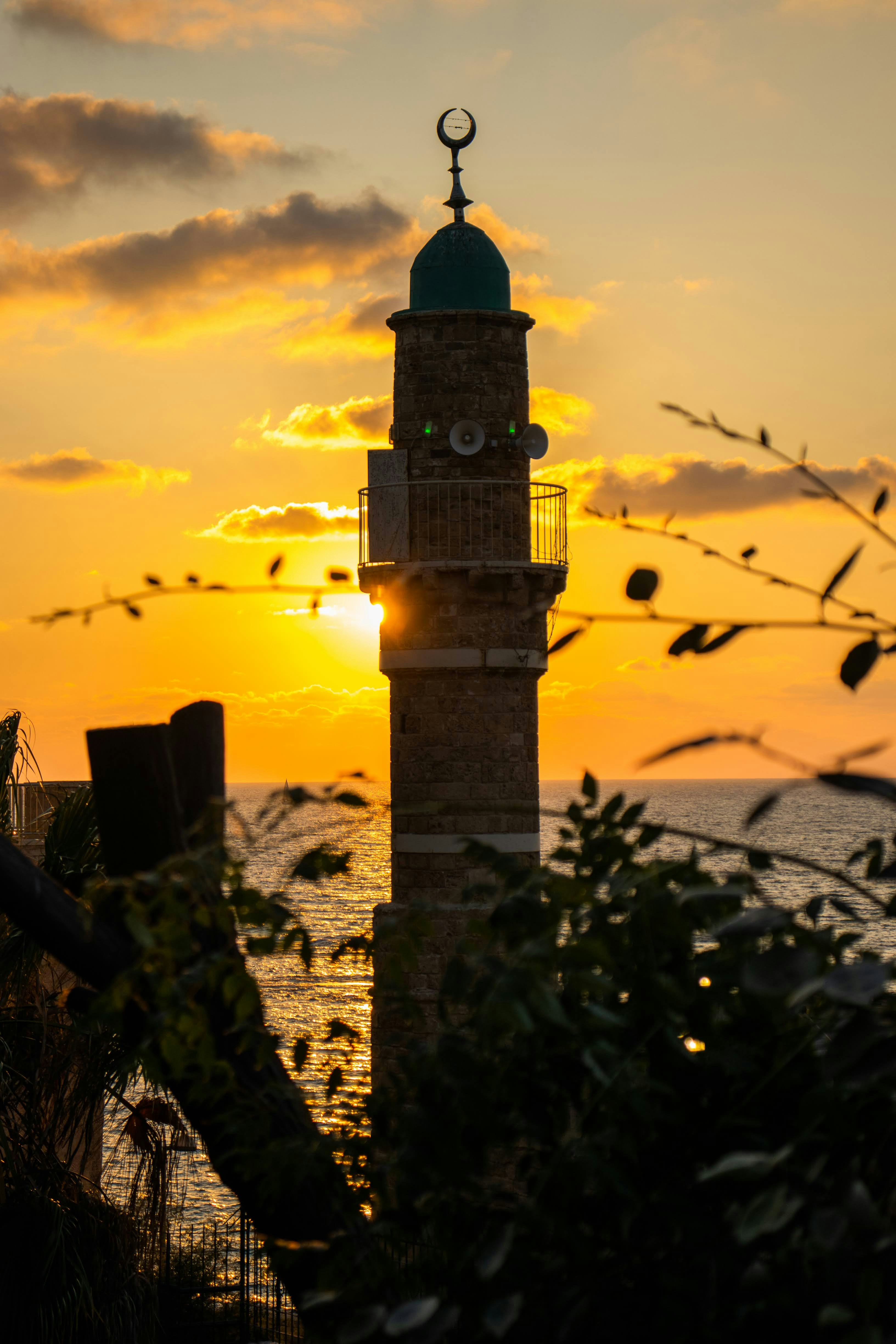 Sunlit Lantern: A Coastal Lighthouse Piercing the Sea