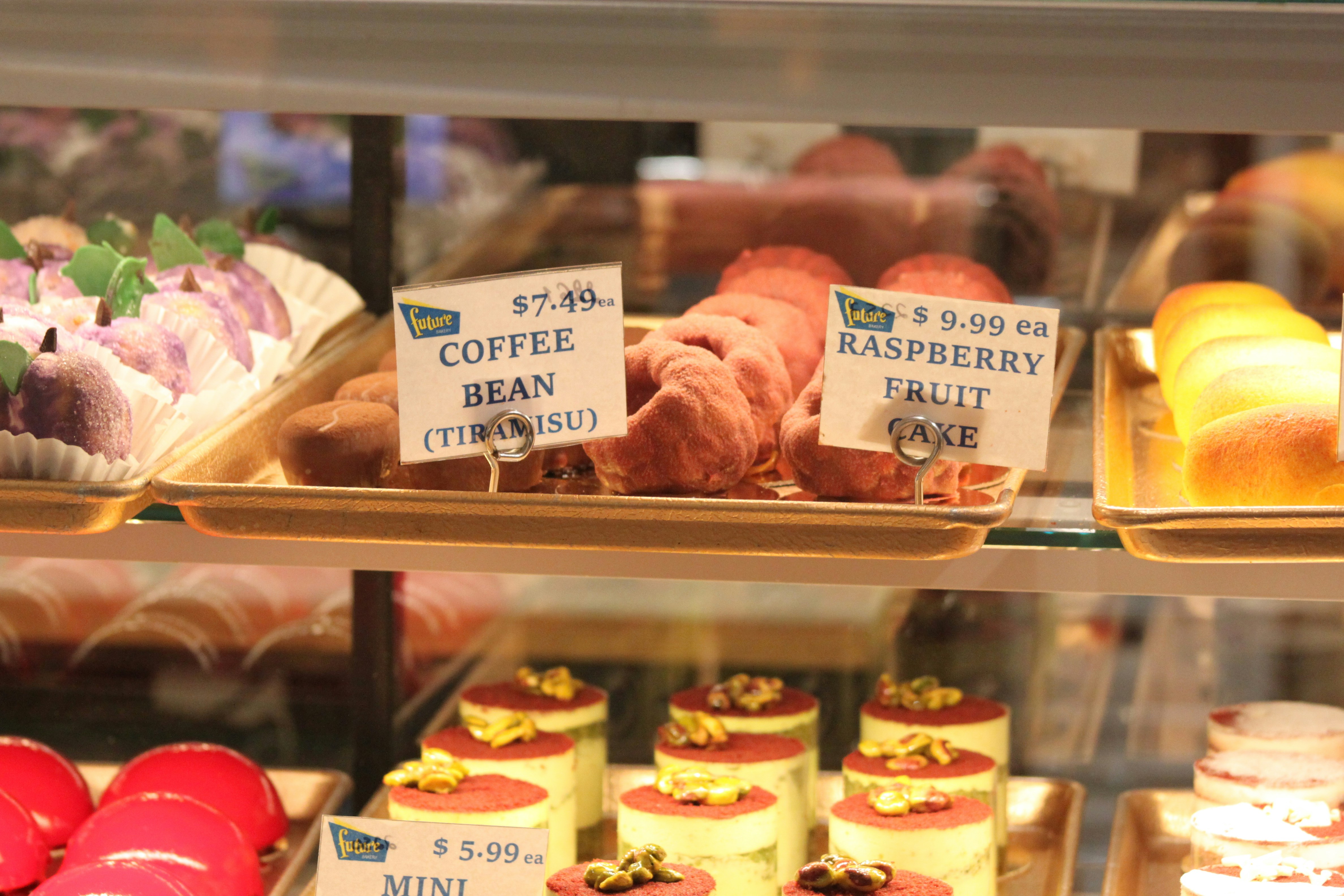 Pastry Showcase: Assorted Cakes and Macarons in a Bakery Display