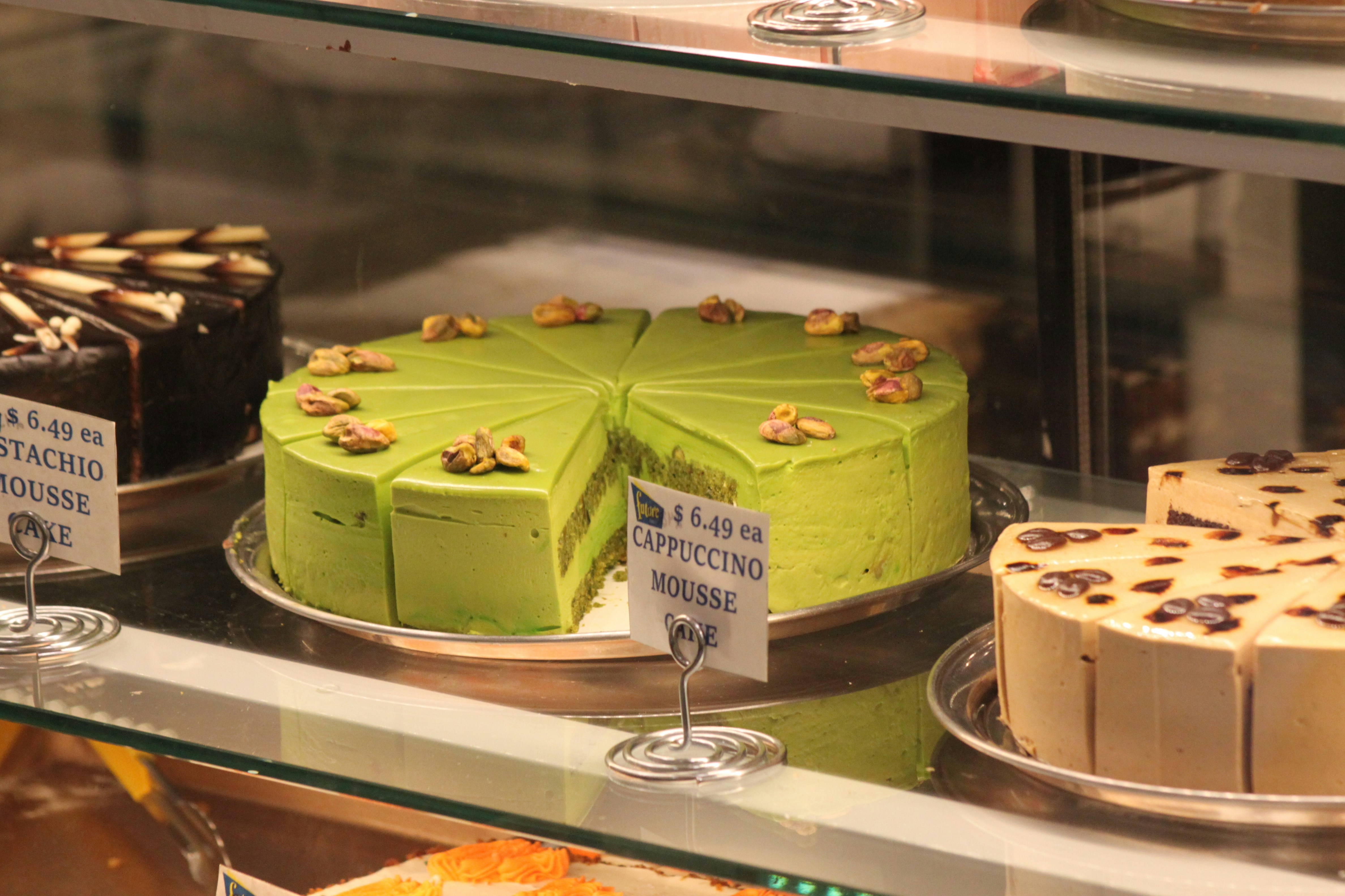 Green Mousse Cake Under Glass: A Slice of Café Delights