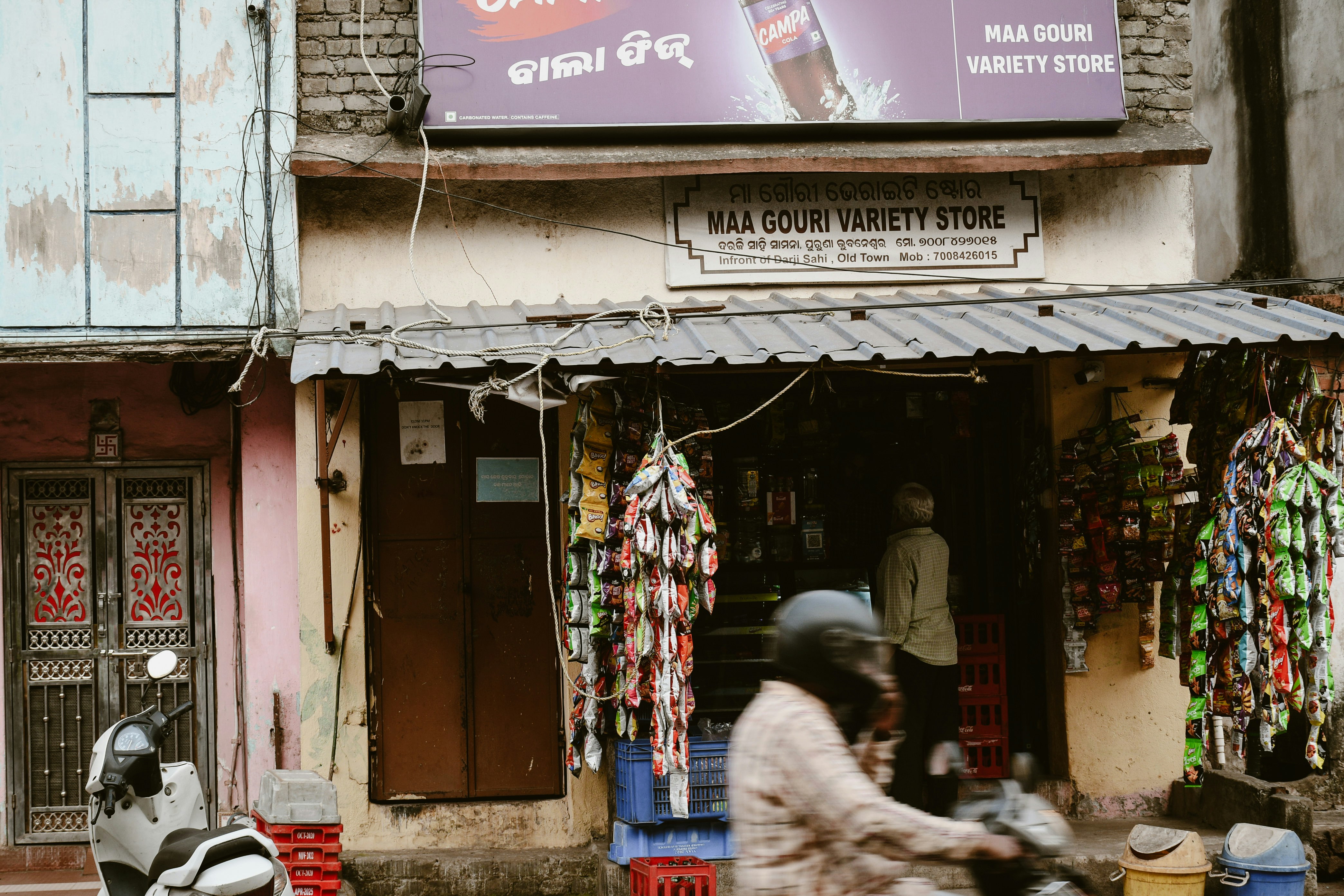 Shopfront Pulse: A Busy Street Scene with Hanging Goods
