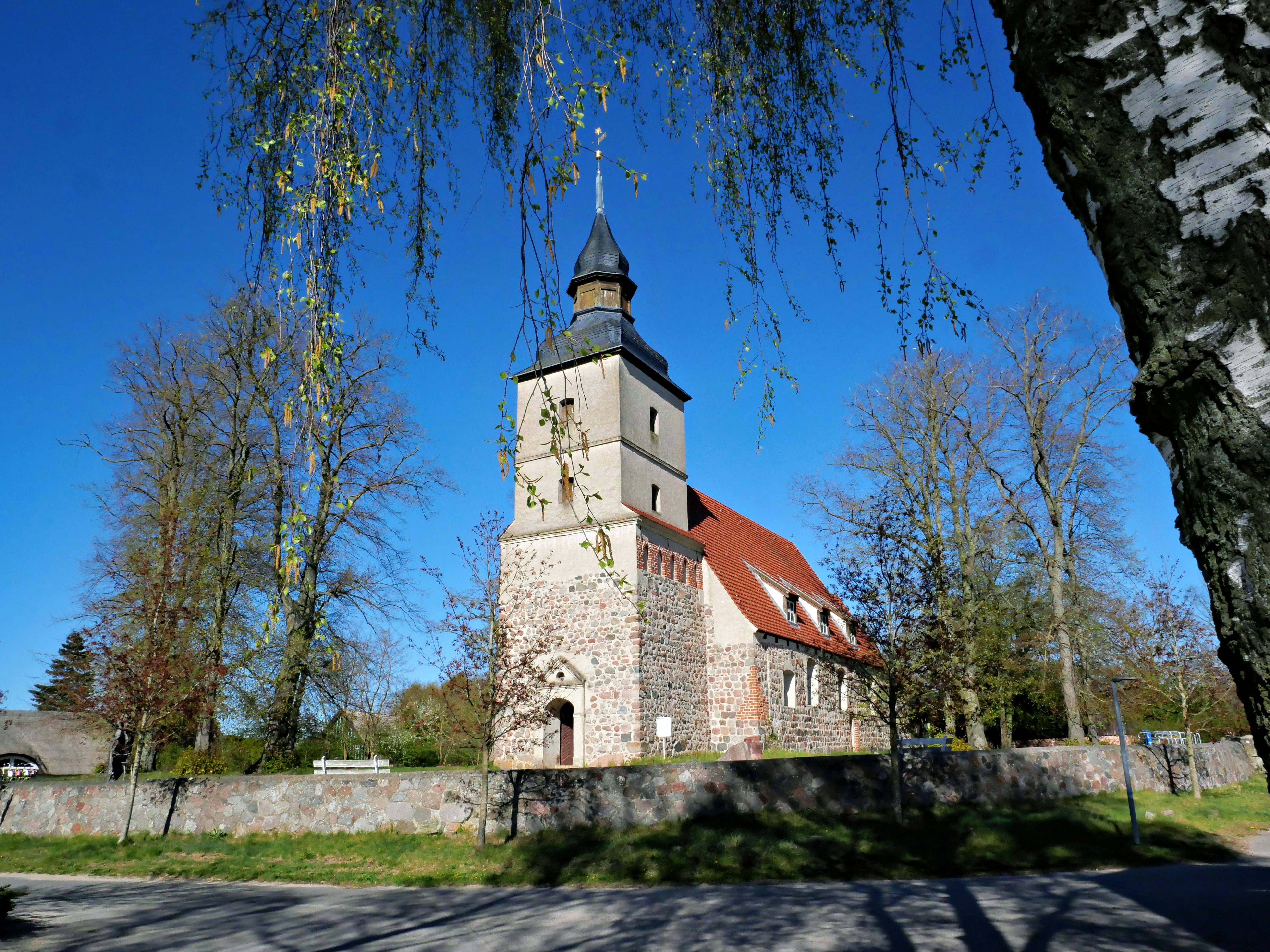 Church with Stone Facade under a Crisp Blue Sky