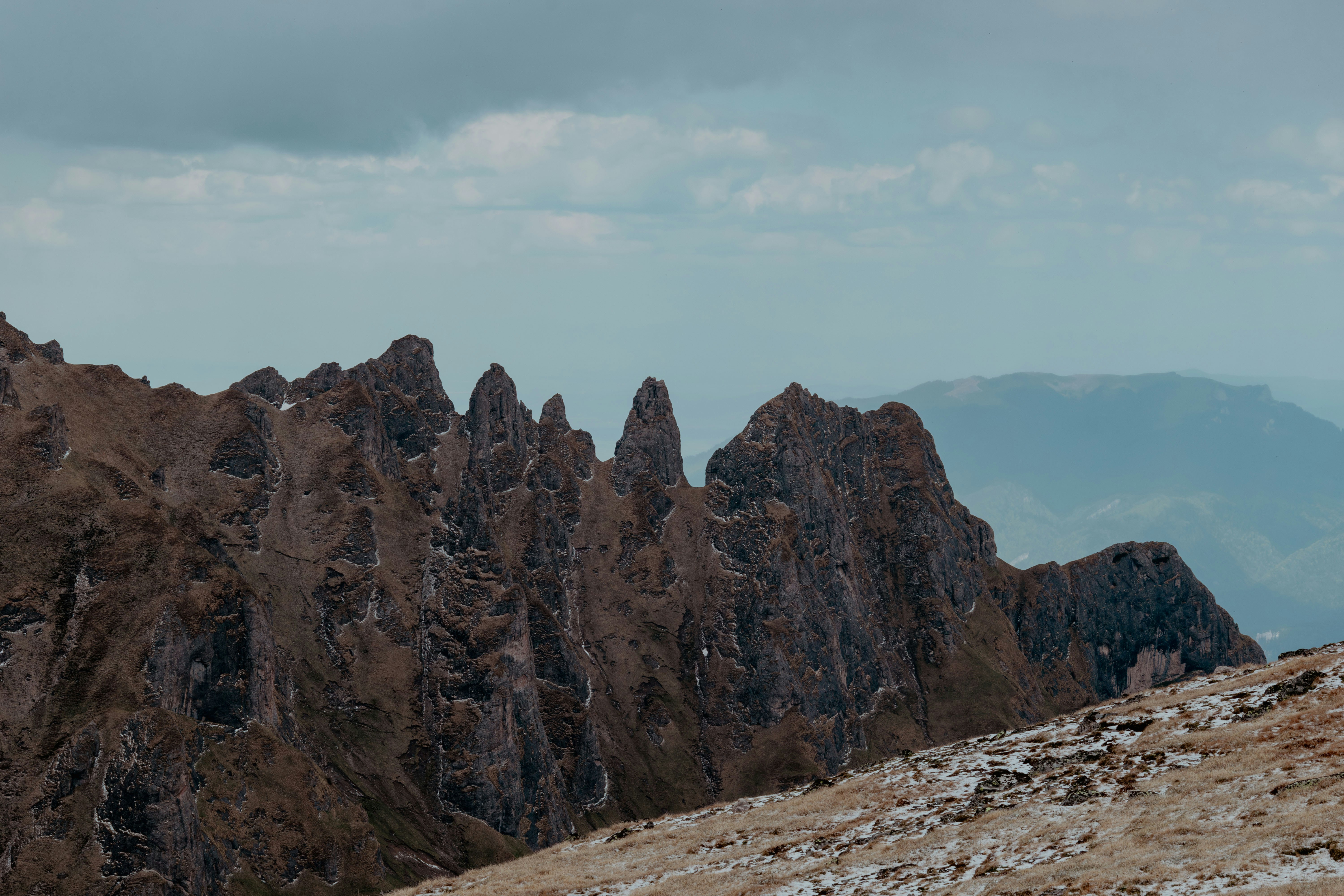 Jagged Crest Under Mist: Alpine Ridge at Distant Dawn