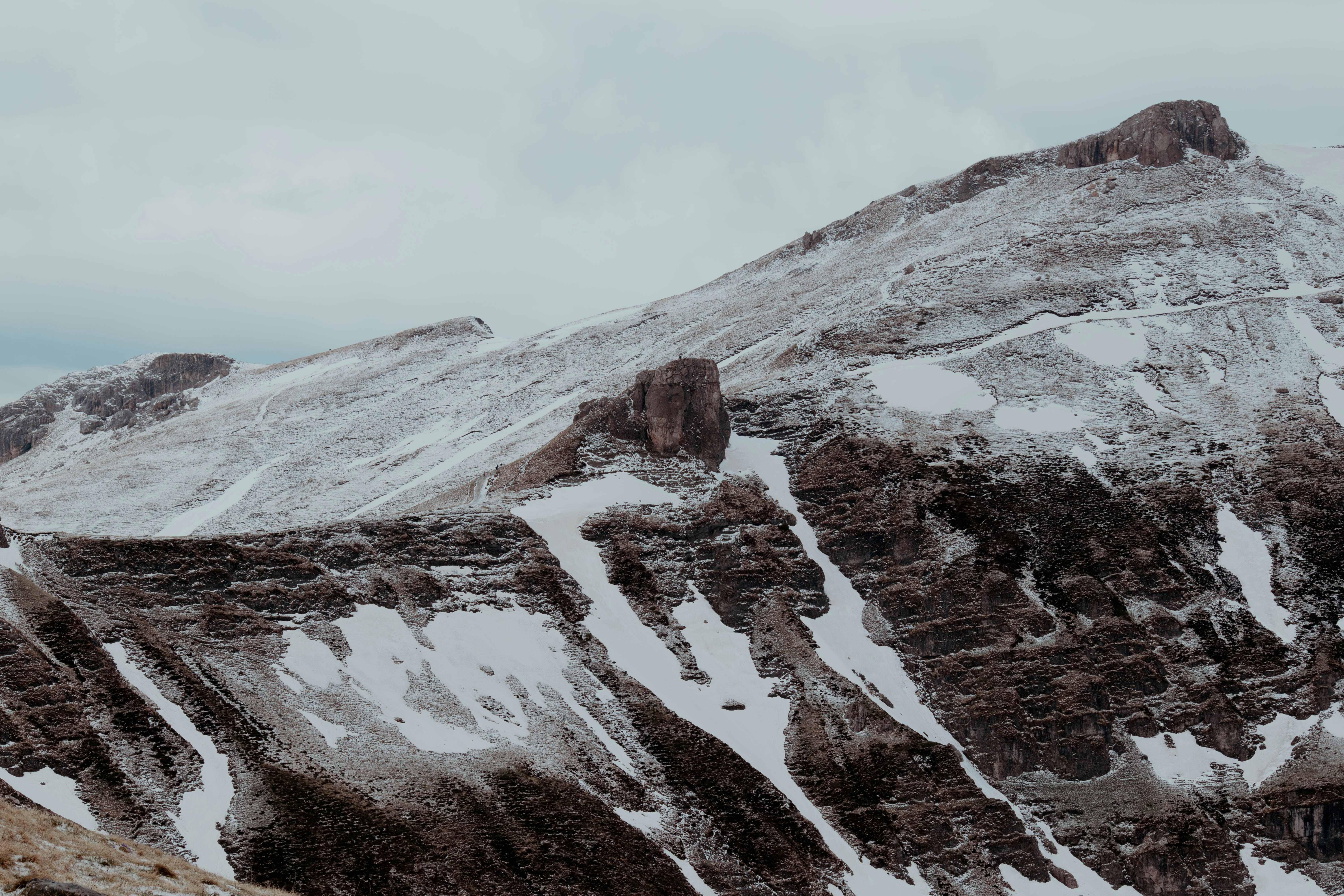 Snow-dusted Alpine Ridge Under a Pale Sky