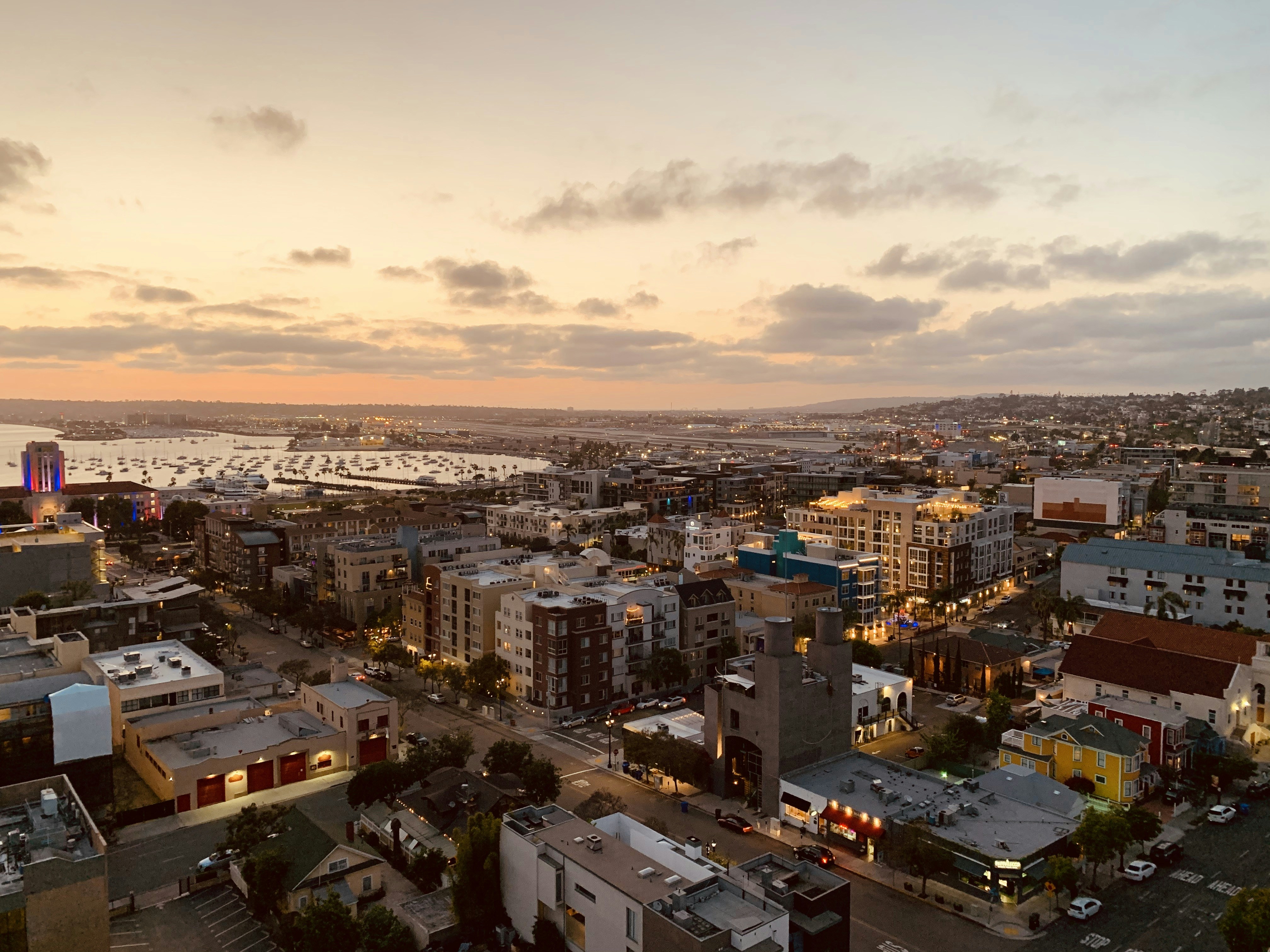 Sunset Over a Coastal City: Dusk Lights Blink Across Rooftops