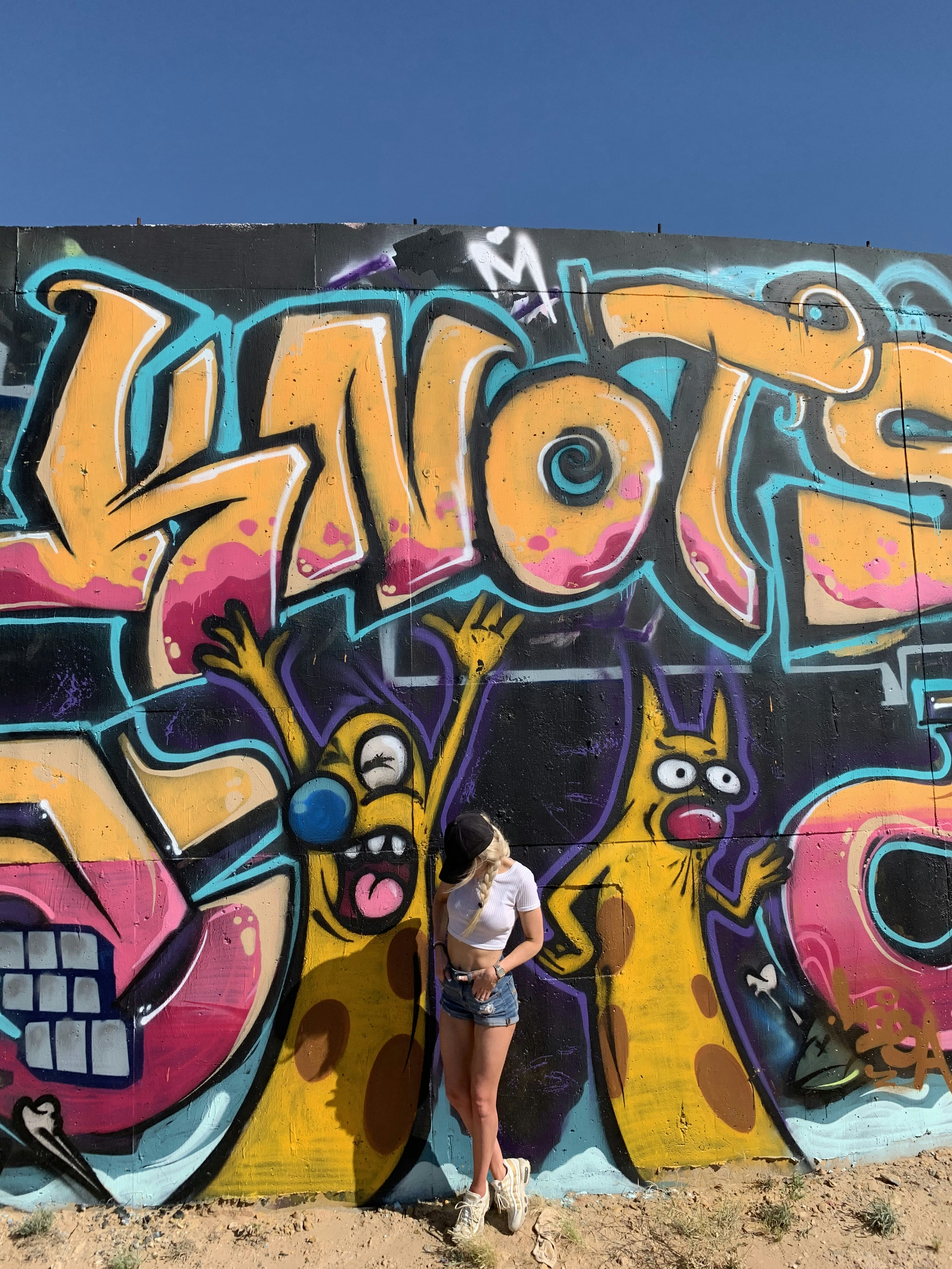 Graffiti Tide: A Girl in Front of Colorful Monsters