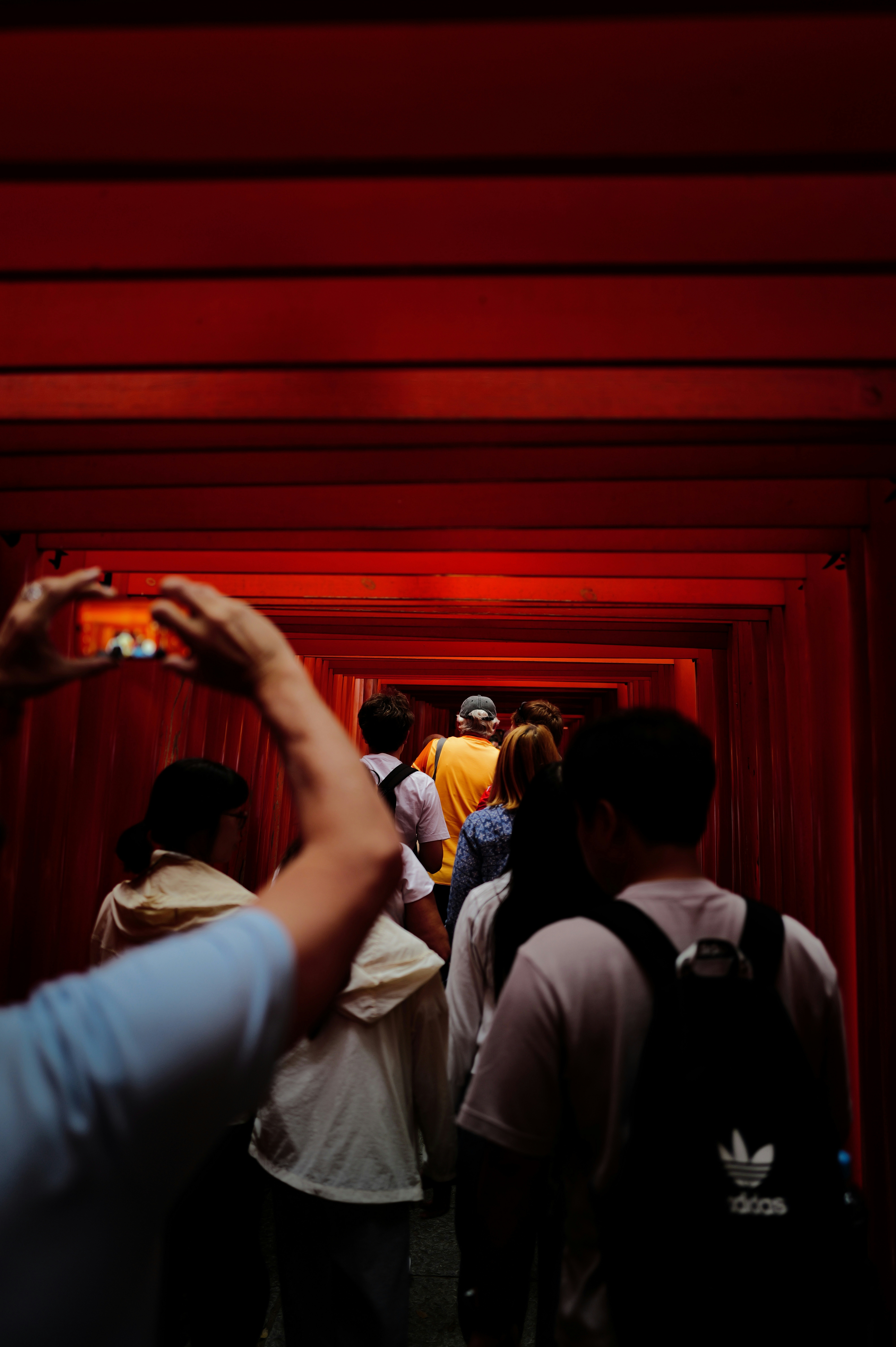 Red Corridor: A Moment in the Tunnel of Passersby
