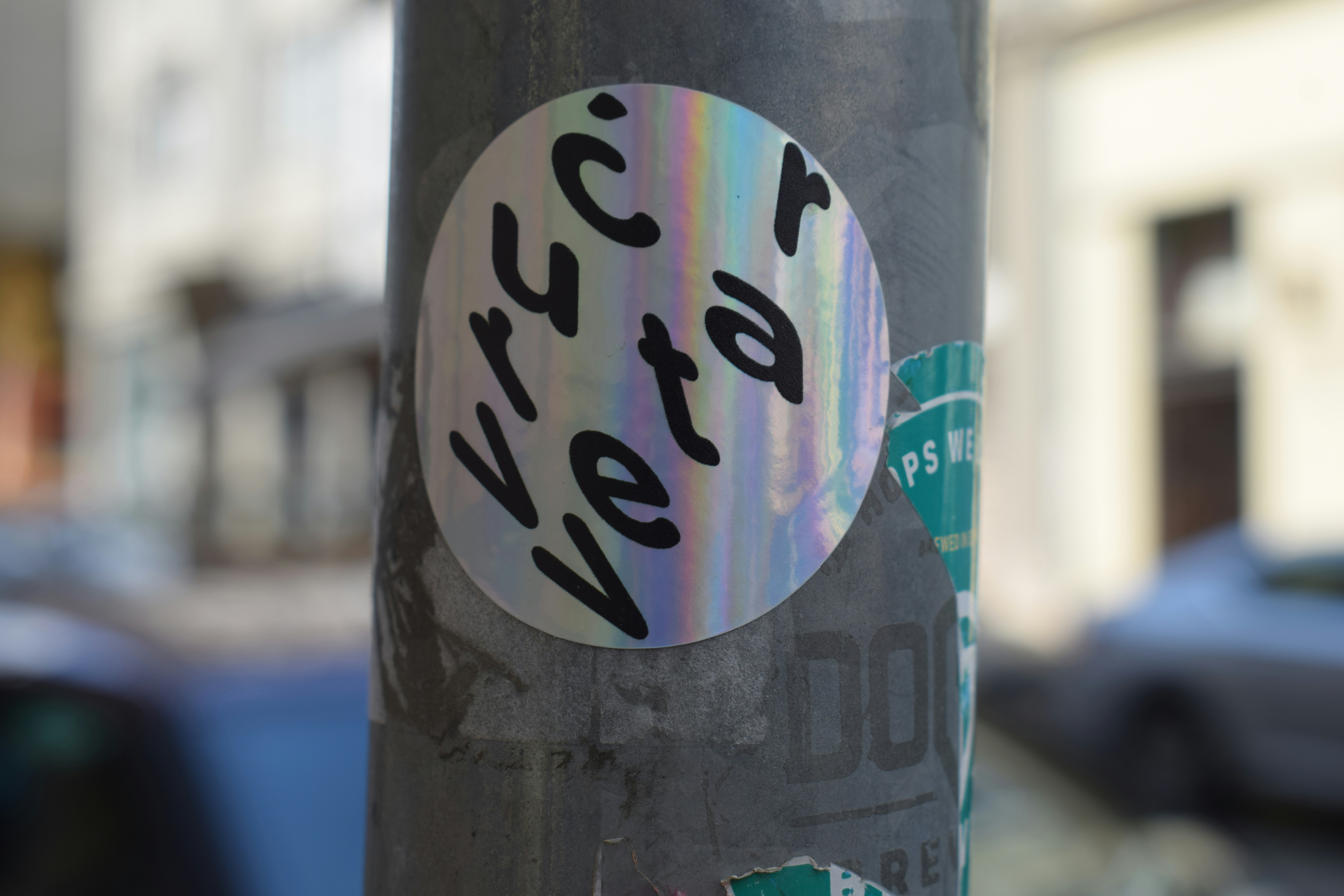 Stickered Pole: Circular Message on a Urban Post