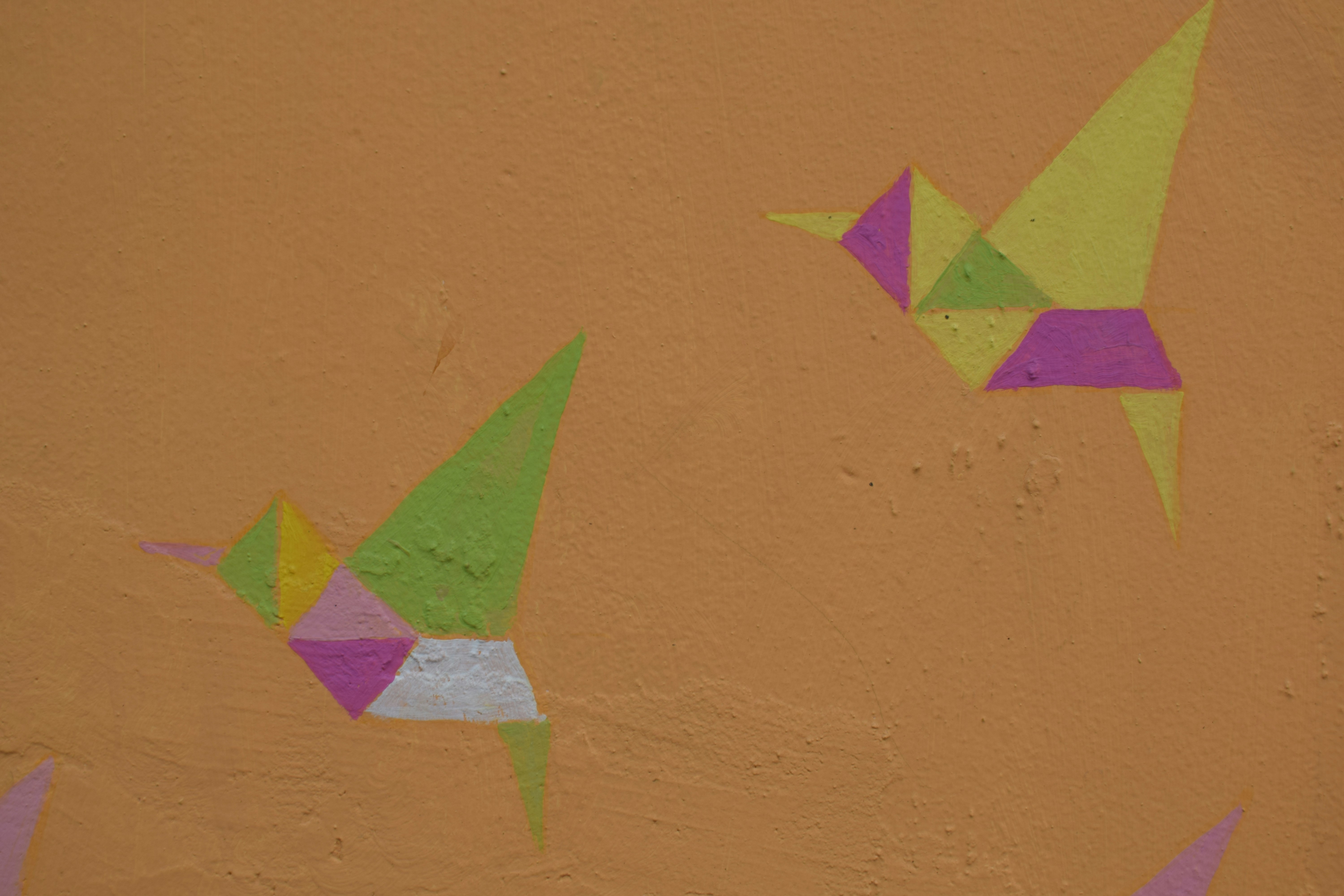Geometric Hues on a Sunlit Orange Wall