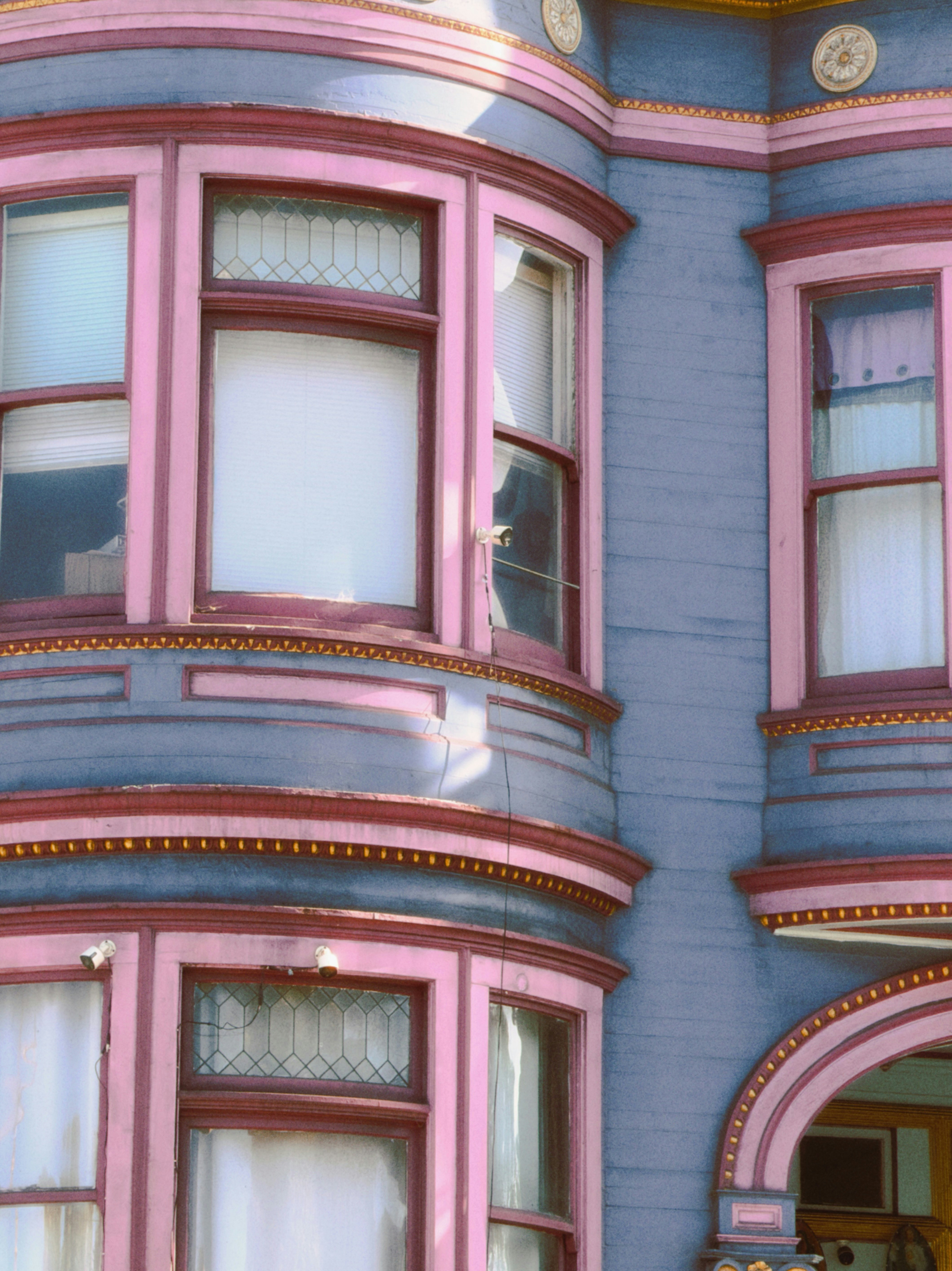Pastel Victorian Facade: Pink Trim on a Velvet Blue Wall
