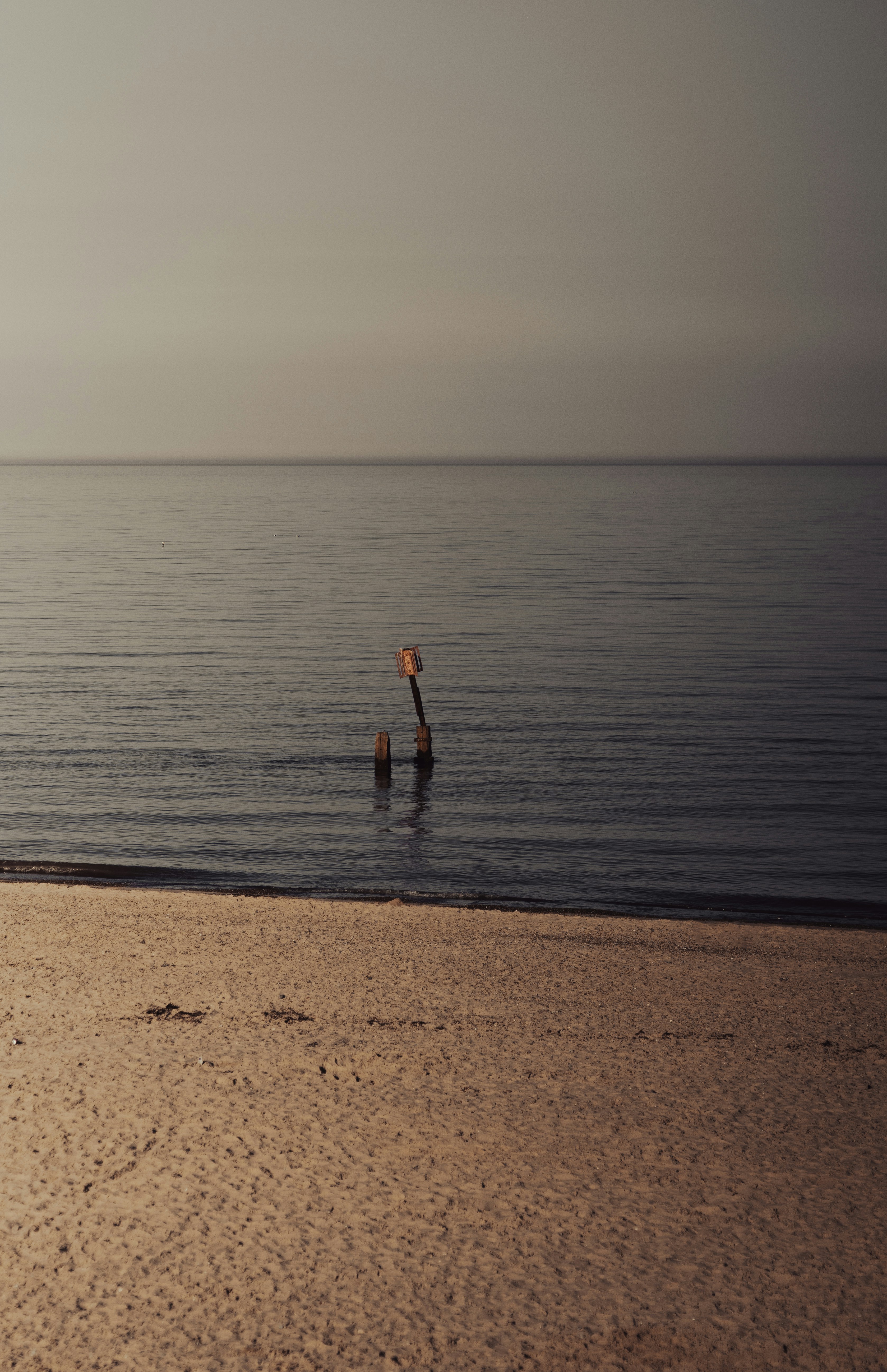 Silent Postcard: A Distant Marker Dips Into Evening Sea