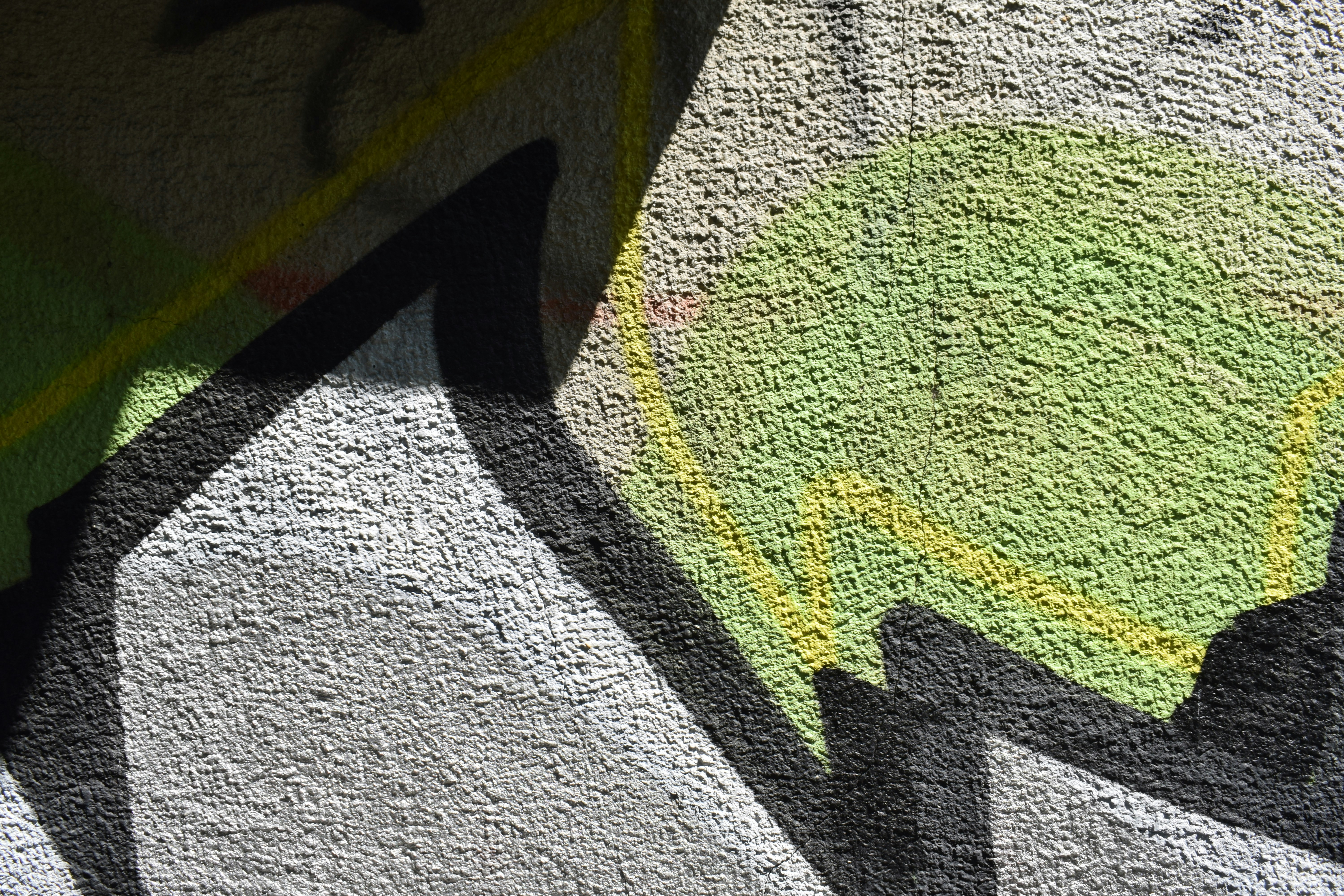 Graffiti Geometry: Concrete Mural with Bold Blacks and Lime Accents