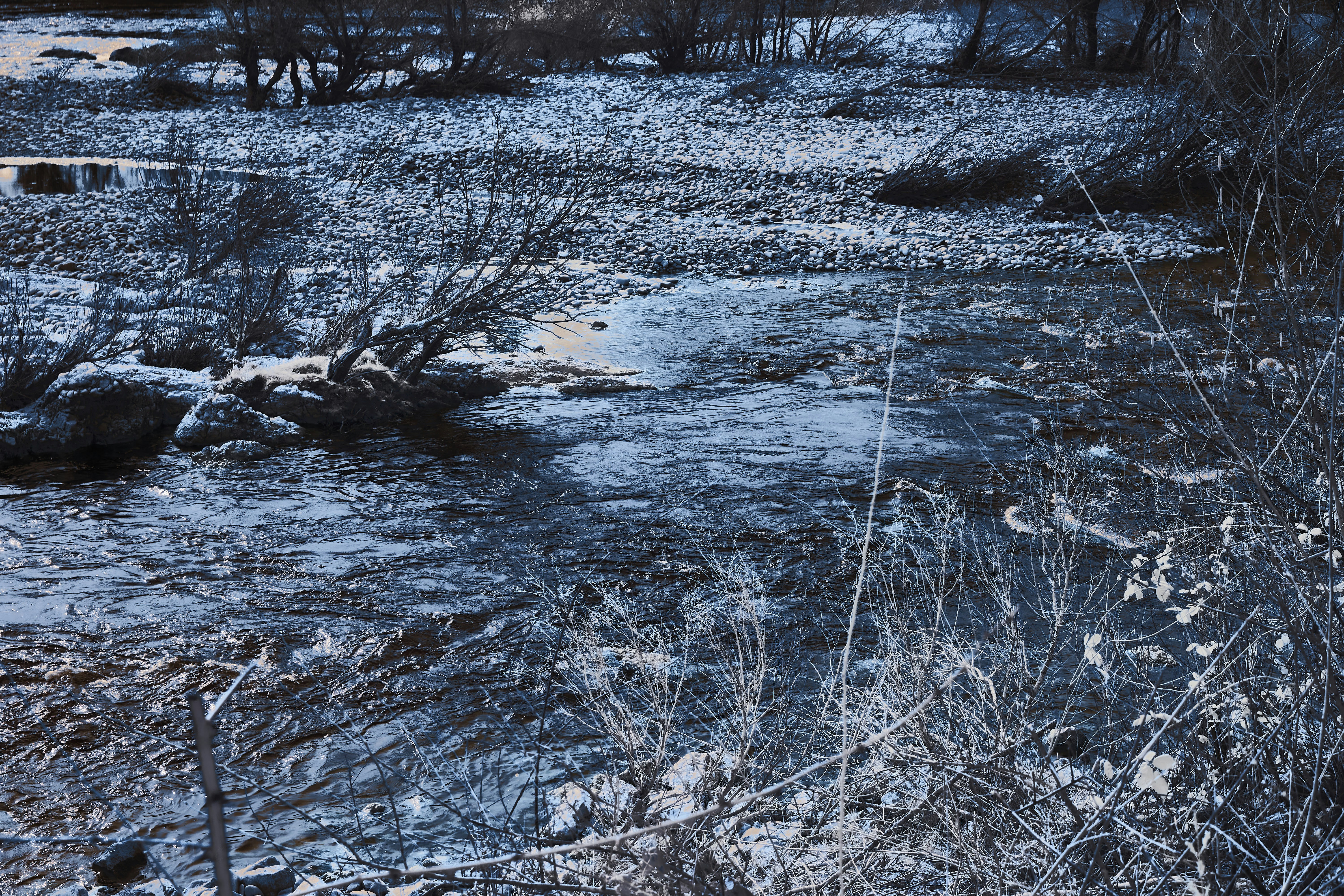 Winter River: Quiet Stream Winding Through Frost-Idled Banks