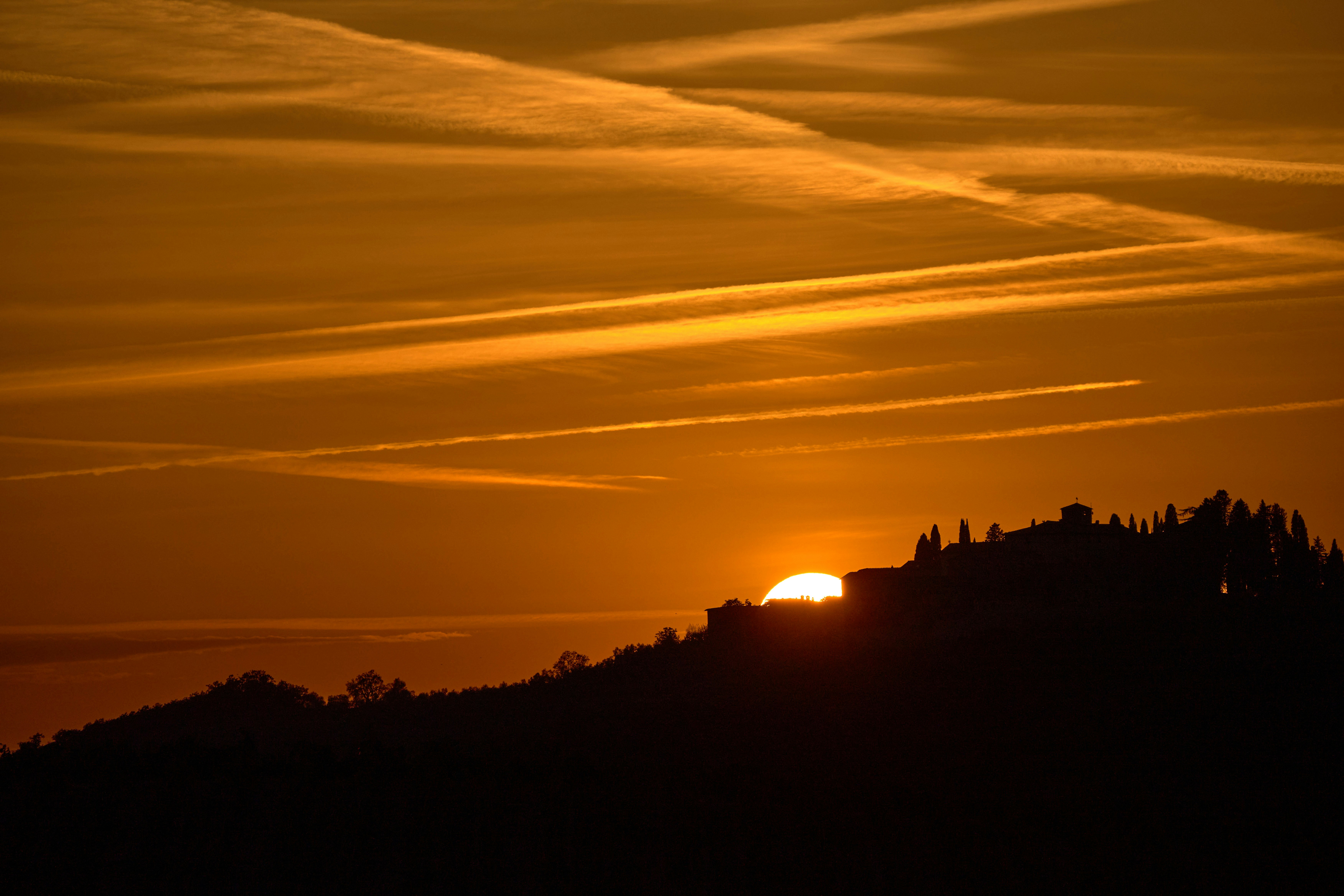 Silhouette at Sunset: Hilltop Horizon