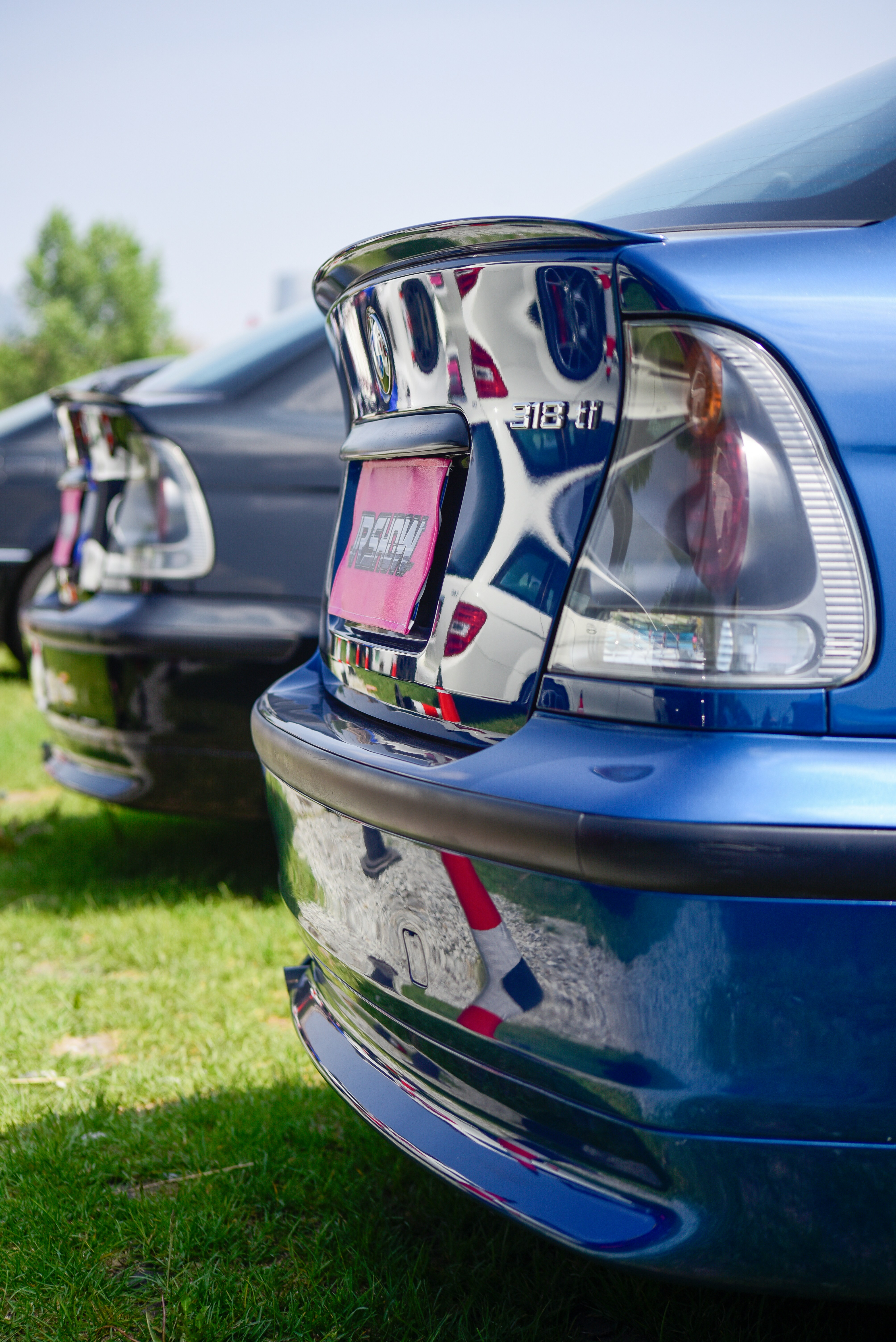 Chrome Reflections: The Front-End of a Blue Car Parade