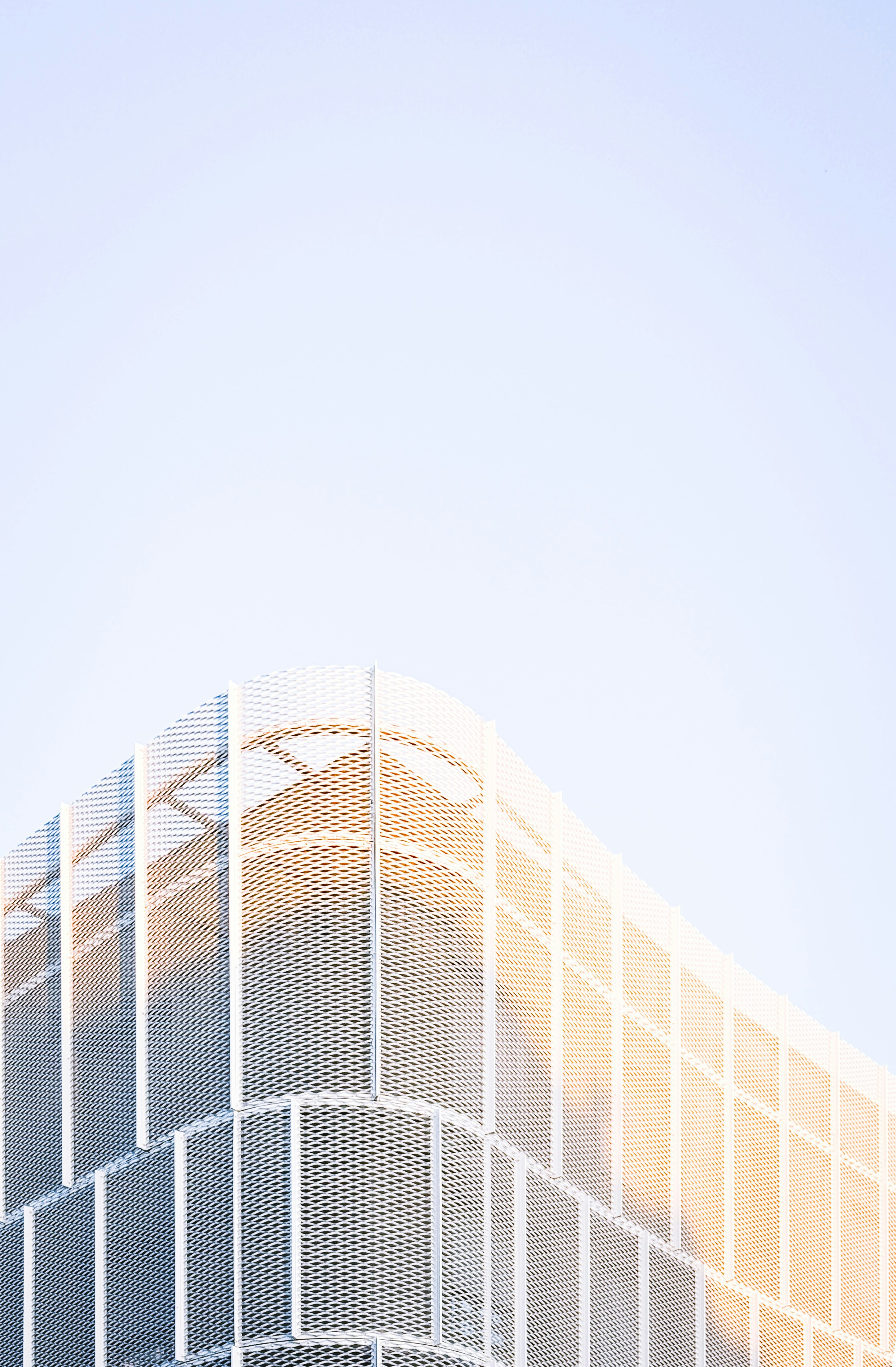 Geometric Glass Facade Reaching Toward a Pale Sky