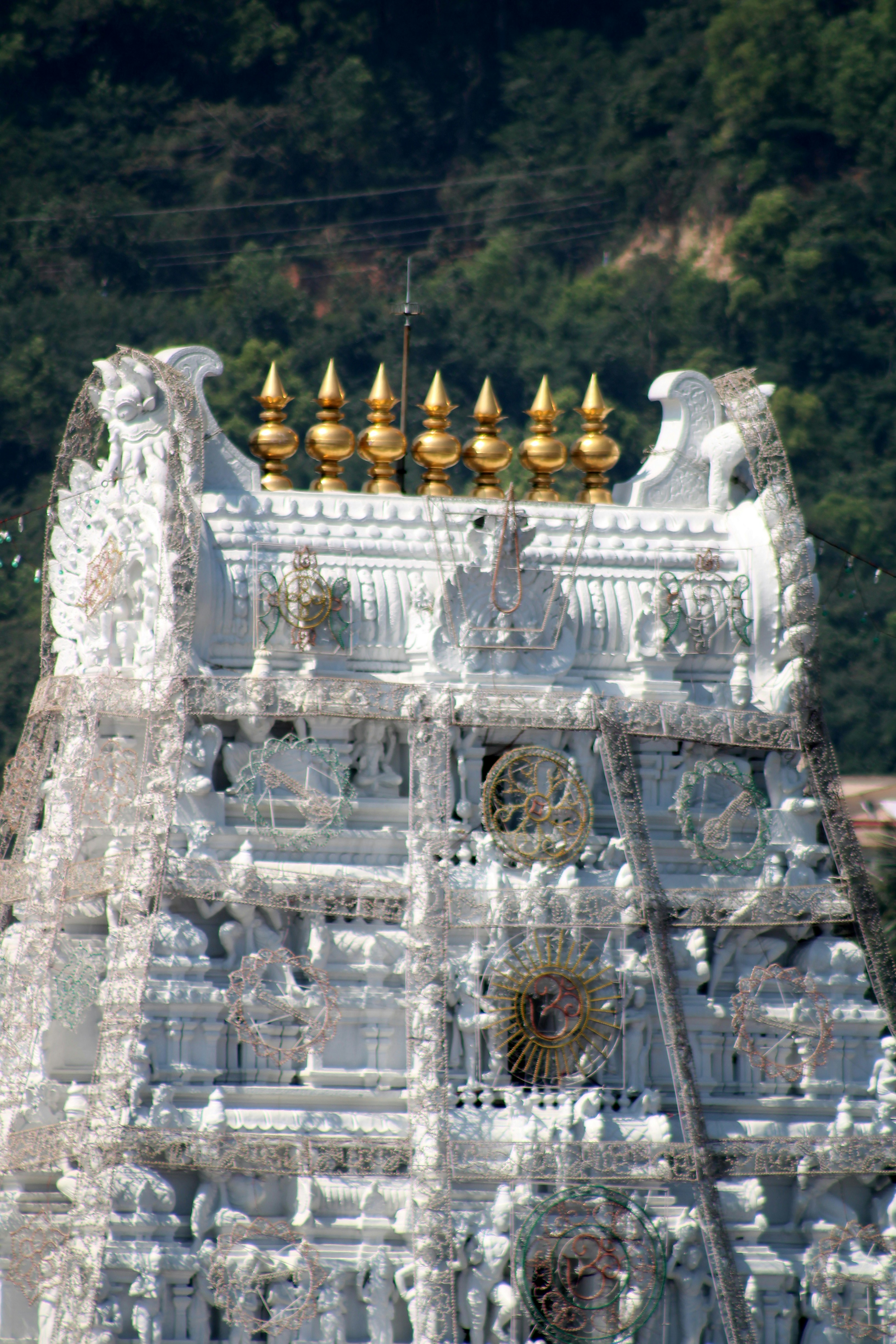 Ornate Reliquary Face: Intricate Carvings Crowned by Golden Spires