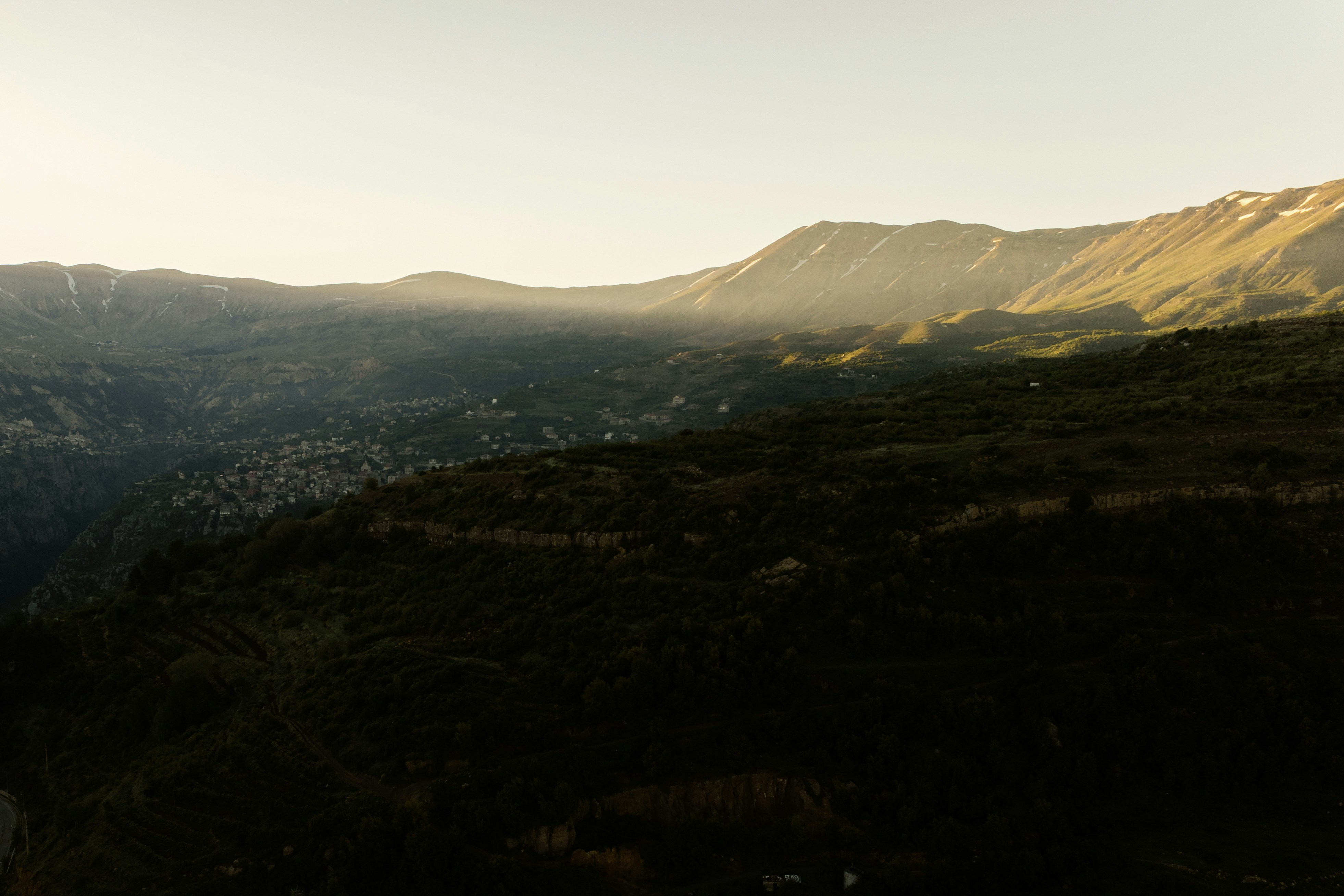Sunlit Ridge Looms Over Quiet Valleys