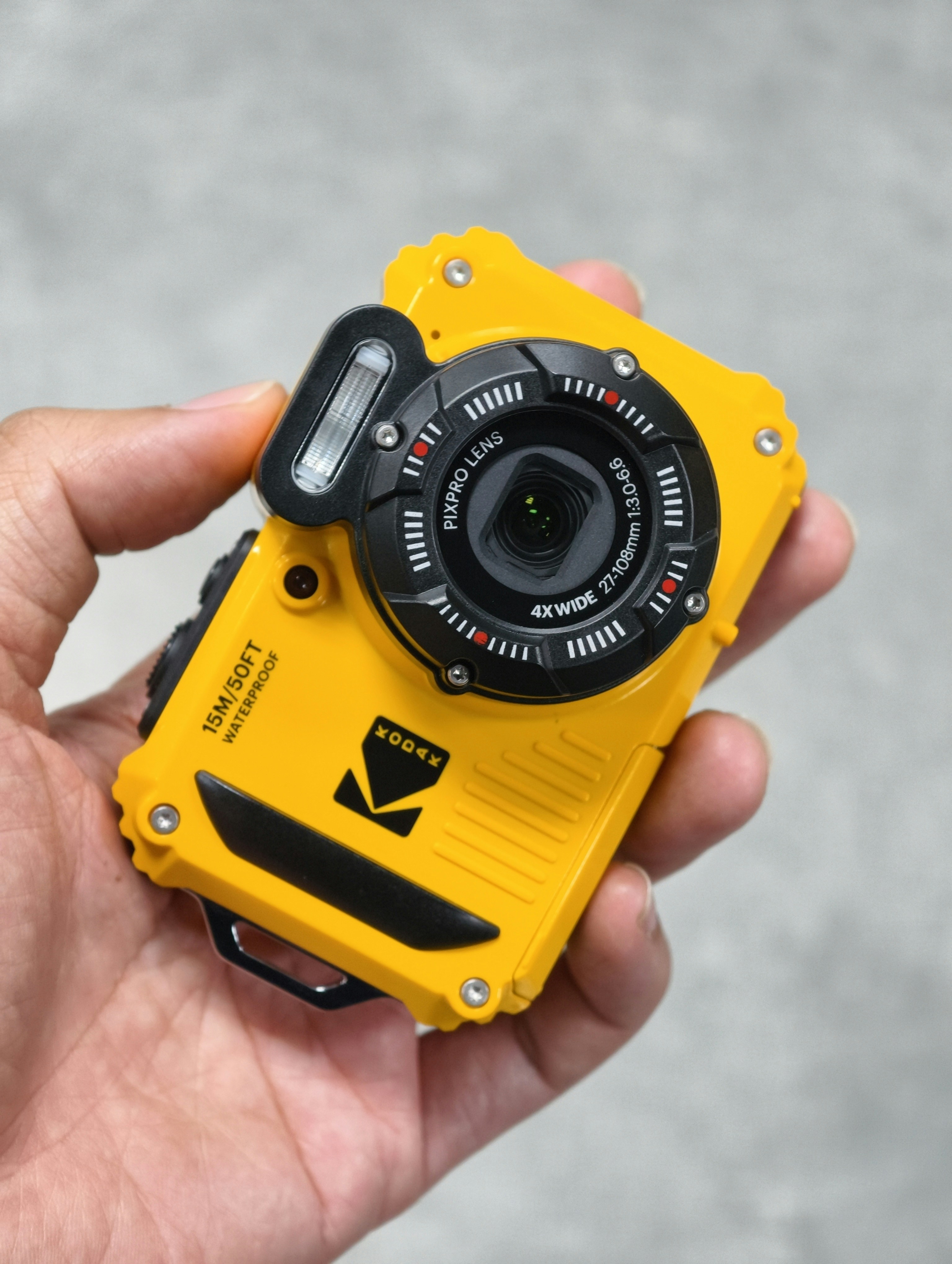 Yellow Rough-and-Tumble: A Handy Action Cam Gripped in Hand