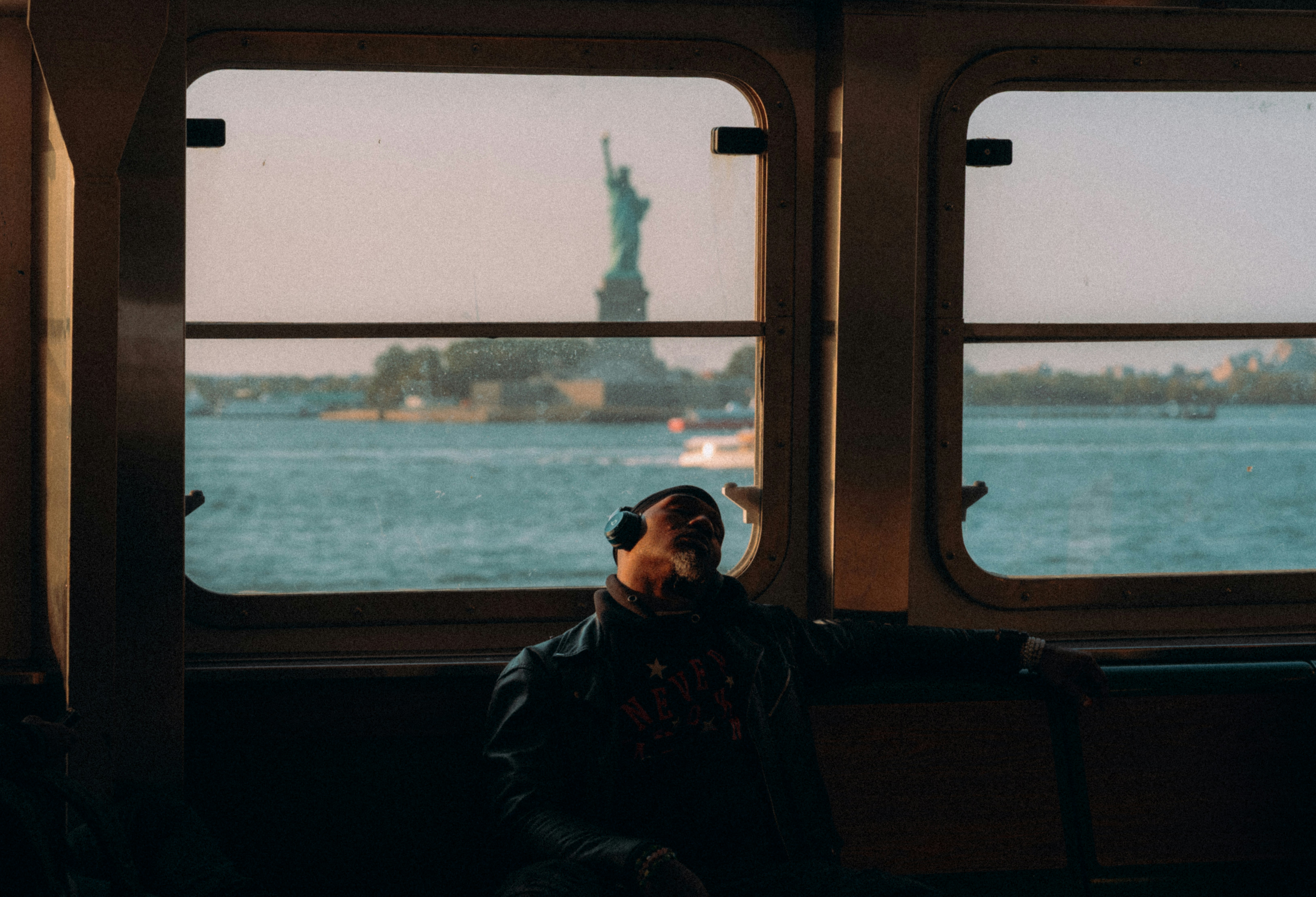 Face Forward: Night Bus Portrait with Statue Across the Water