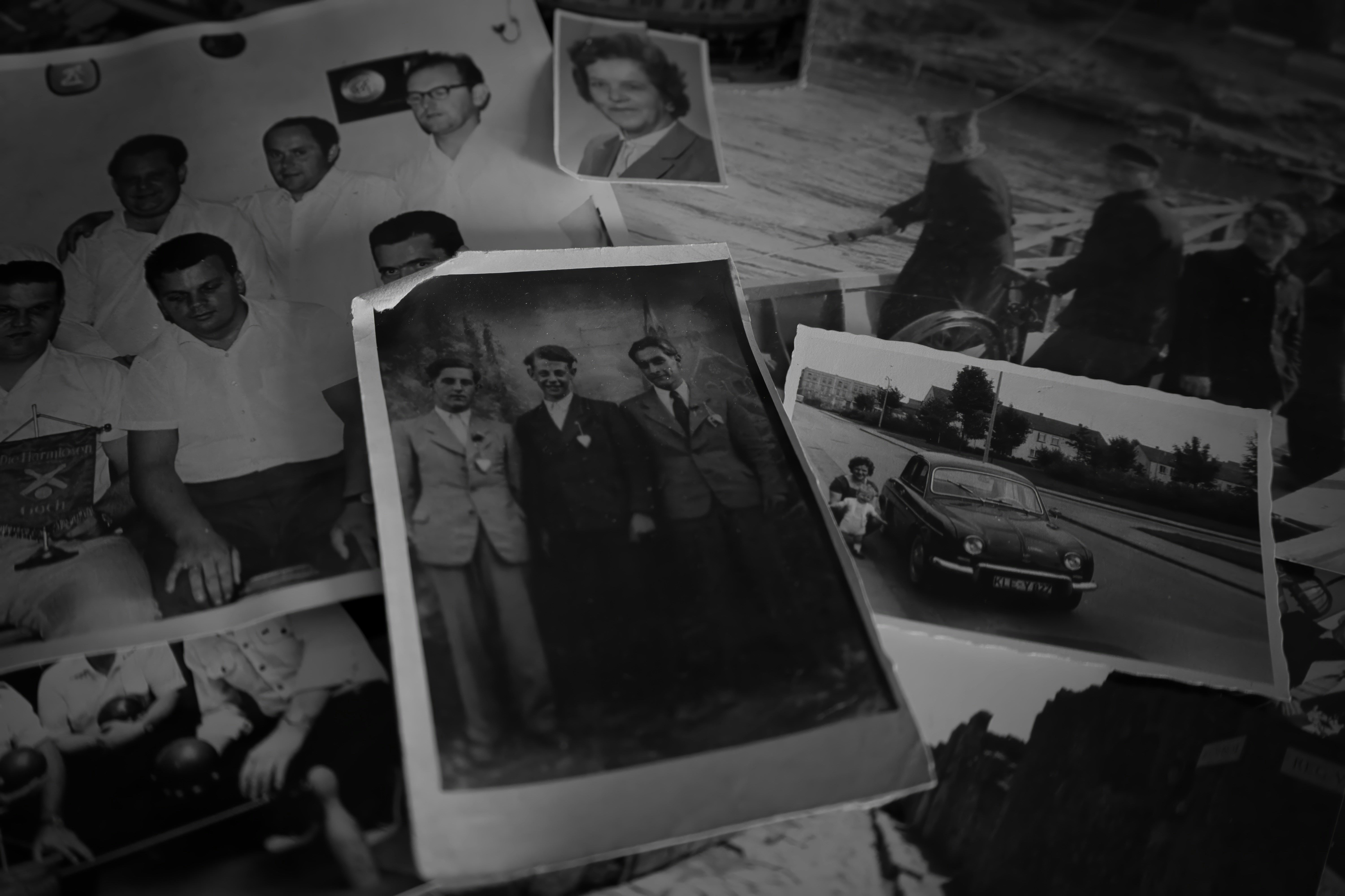 Dusty Memories: Vintage Polaroids Scatter Across a Weathered Table