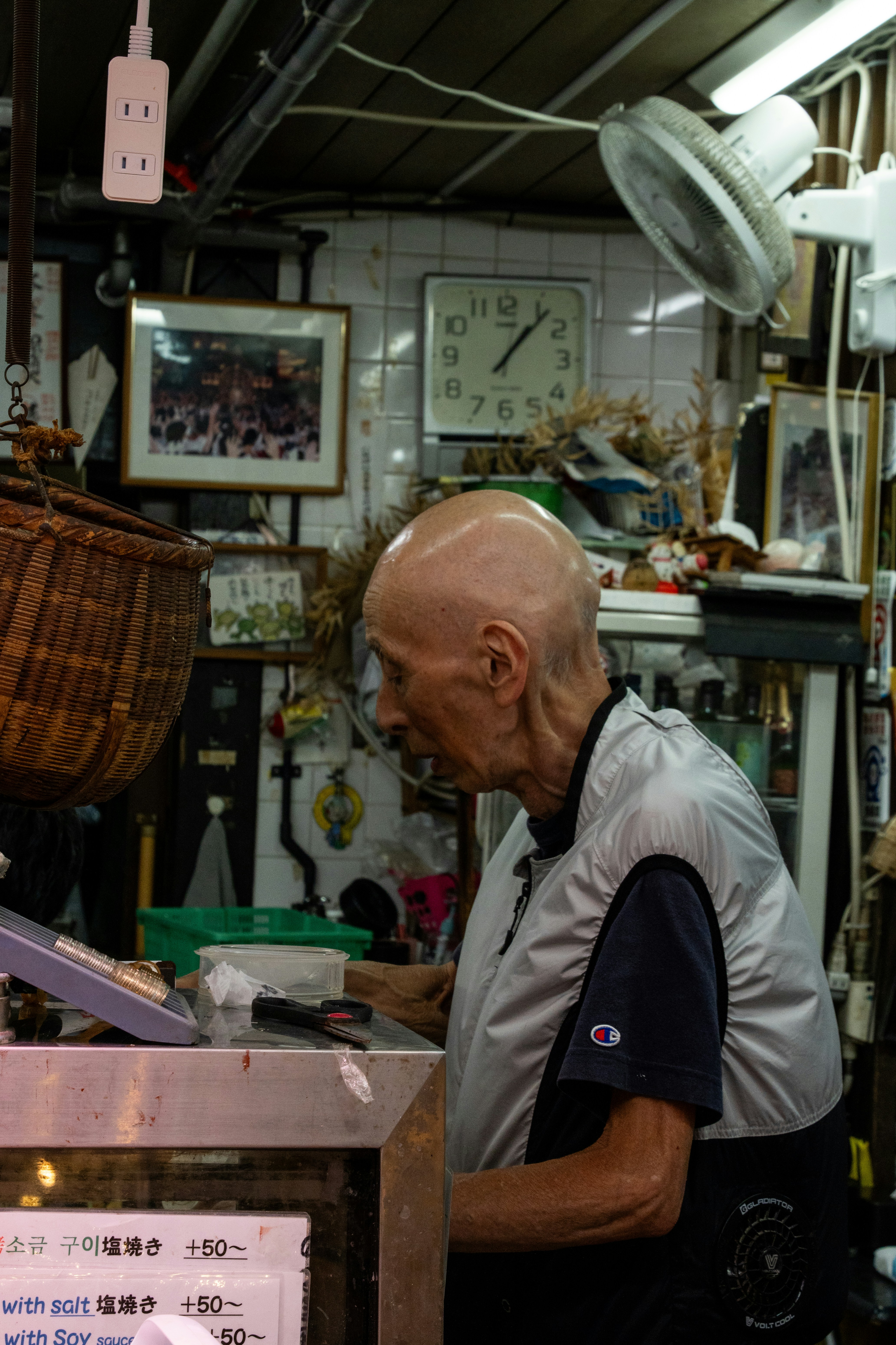Beneath the Market Lights: A Quiet Moment in the Stall
